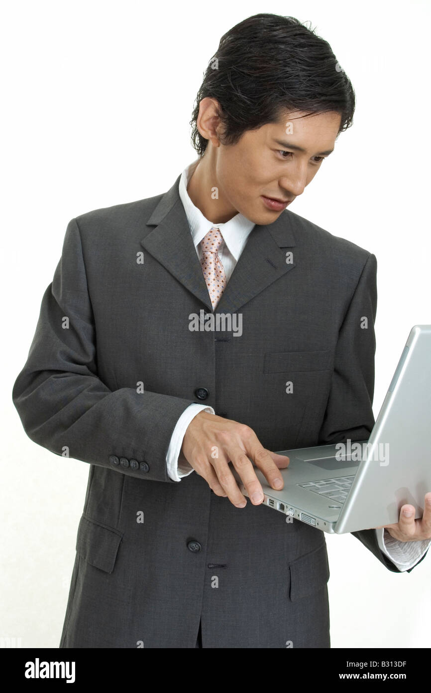 An asian businessman using a laptop computer Stock Photo - Alamy