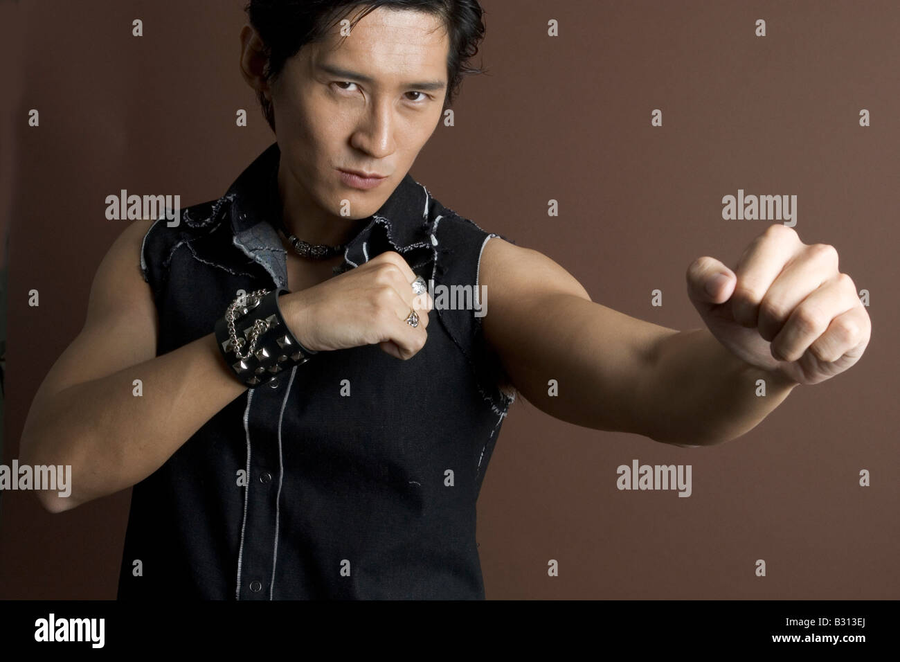 An asian male model throws a punch Stock Photo - Alamy