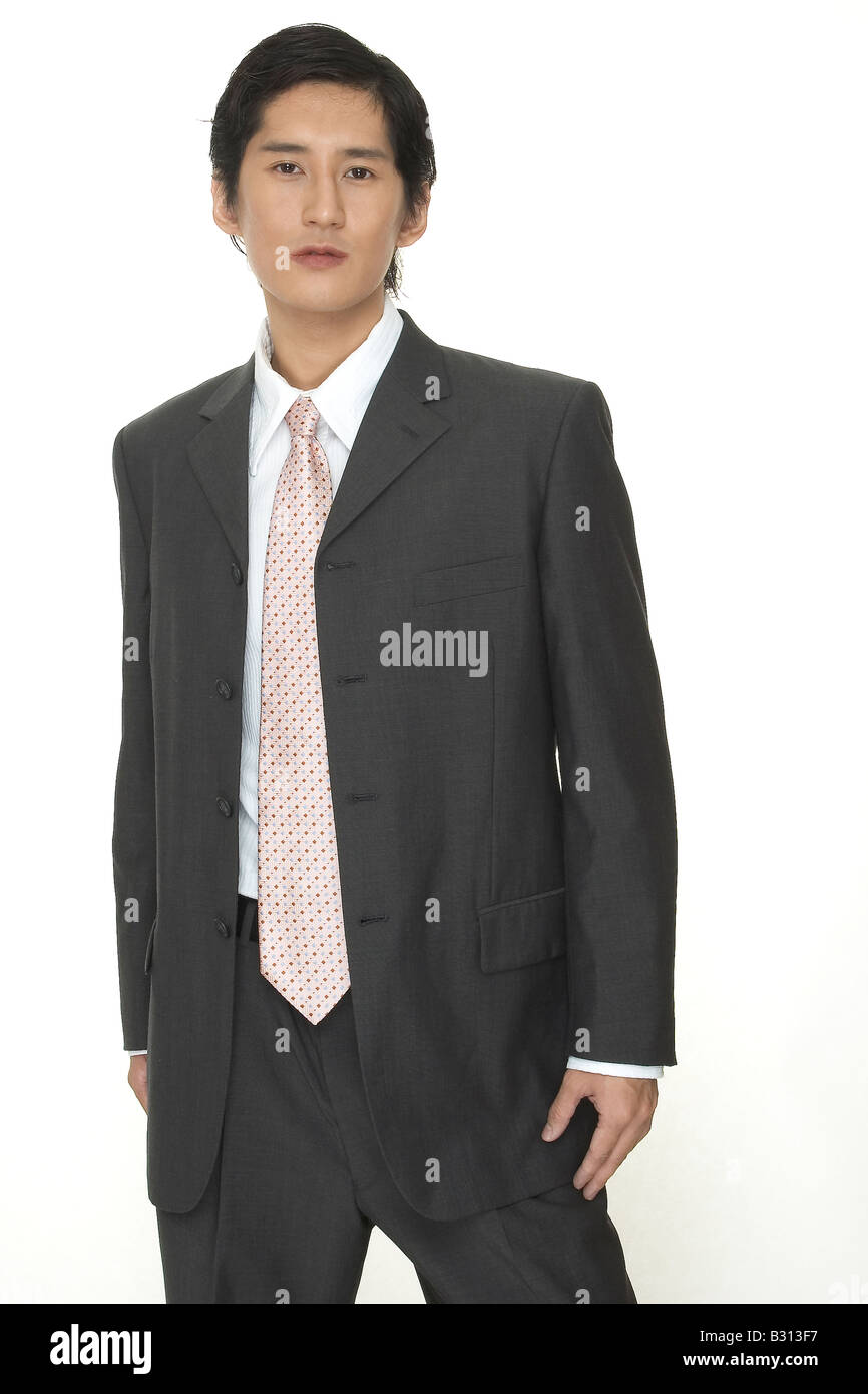 An asian businessman in a smart grey suit with pink tie Stock Photo - Alamy
