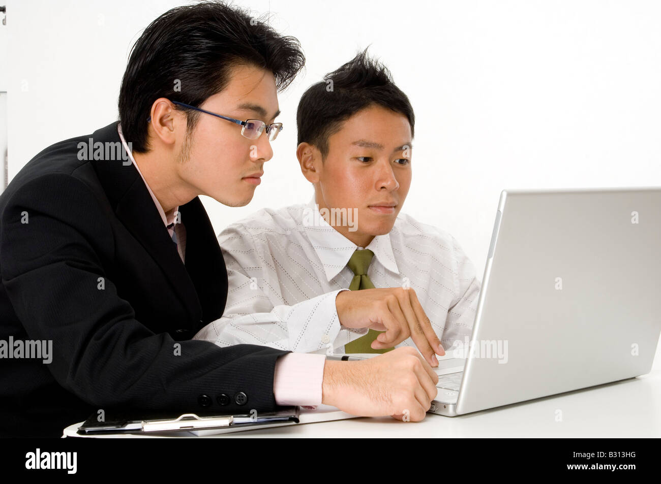 Serious couple working laptops hi-res stock photography and images - Alamy