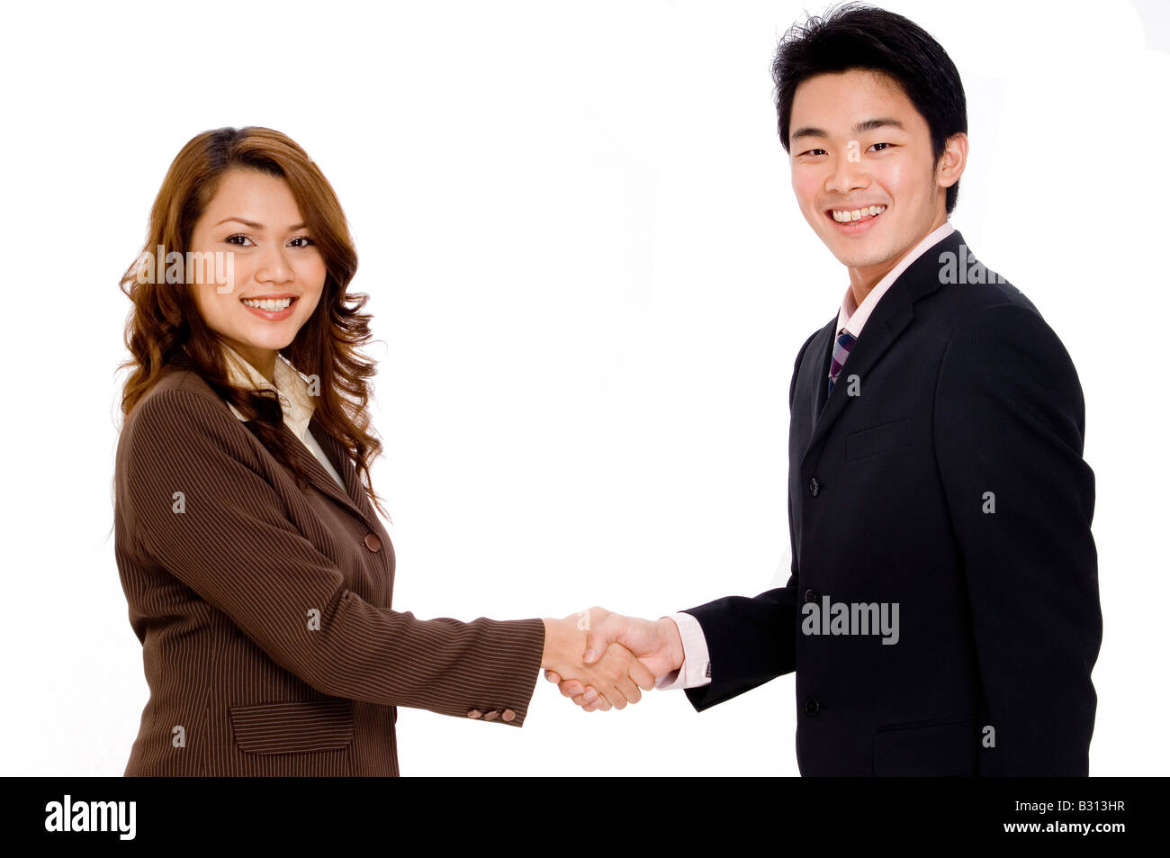 Business couple shaking hands Cut Out Stock Images & Pictures - Alamy