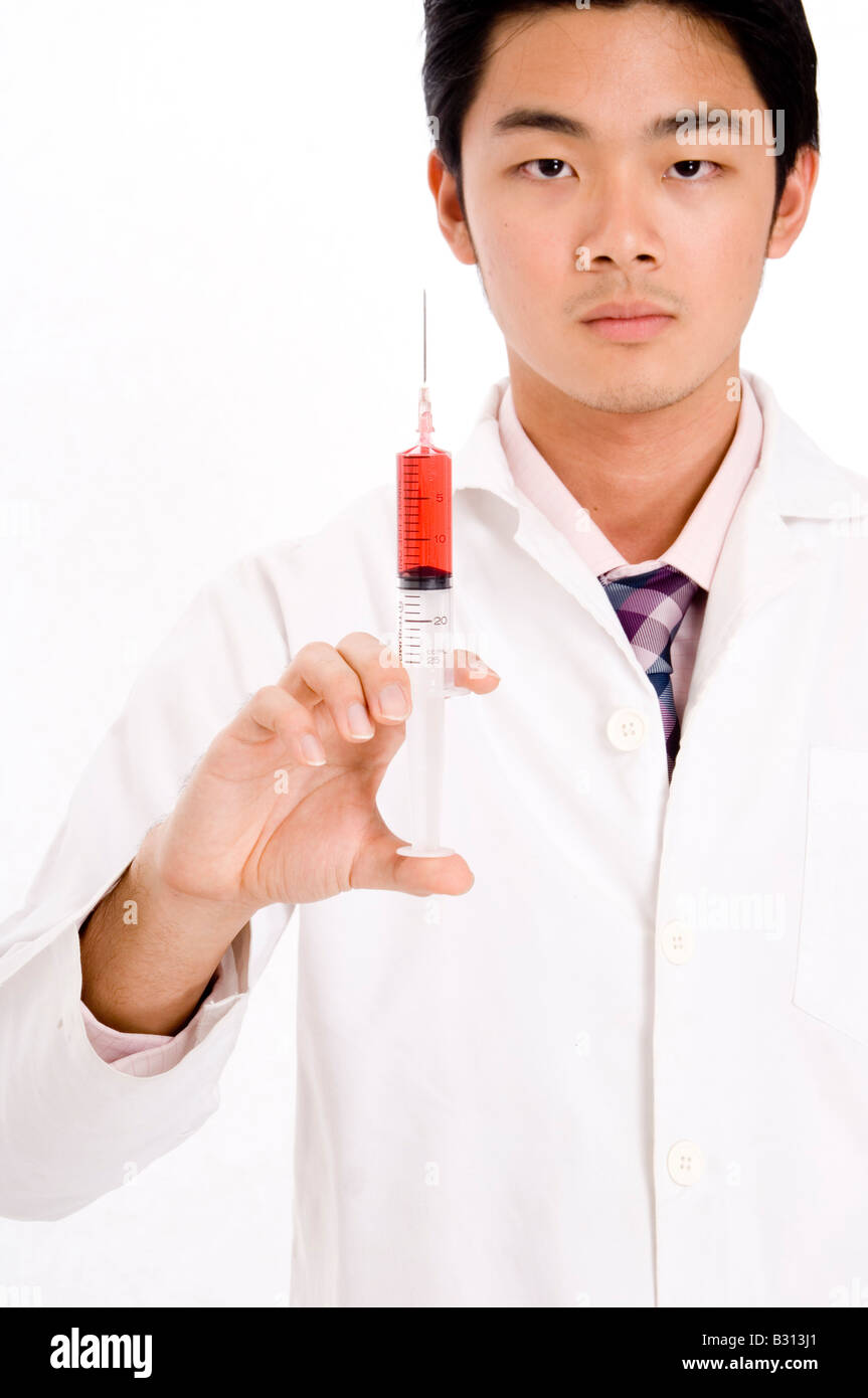 A stern doctor holds a syringe and needle Stock Photo - Alamy