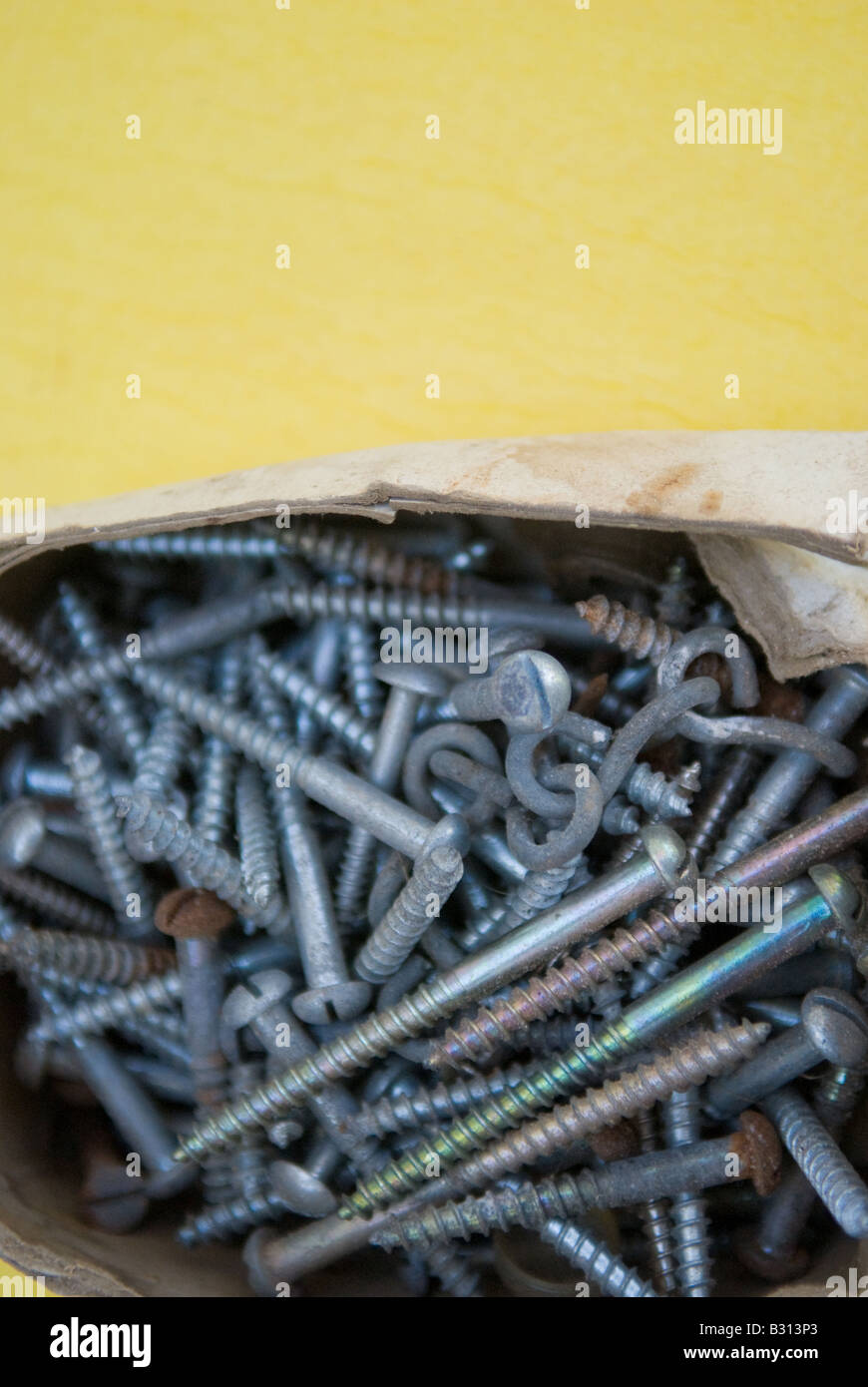 various screws and fittings in bo against yellow background Stock Photo ...