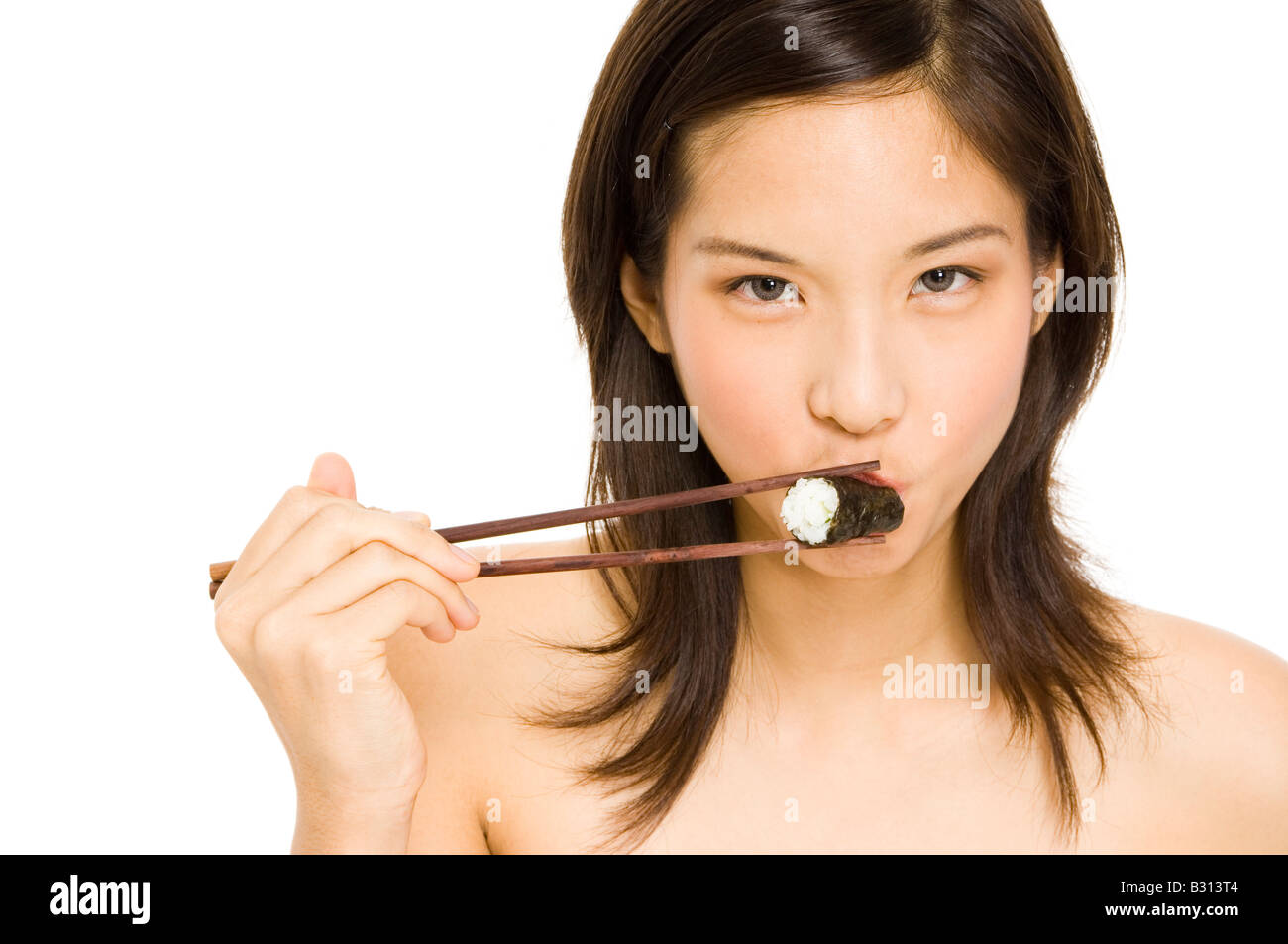 A pretty young girl bites into a sushi roll Stock Photo - Alamy