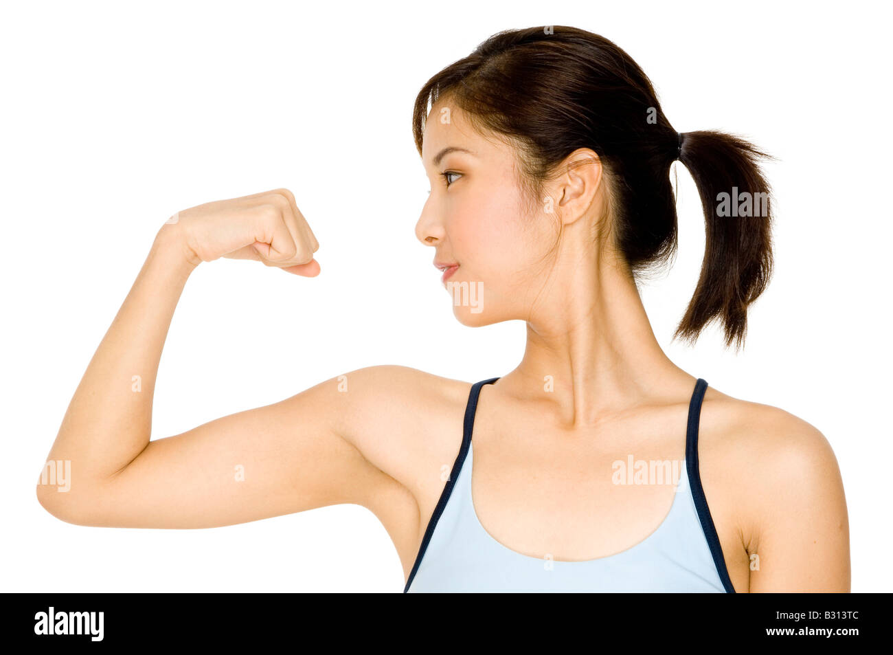 A pretty young asian woman flexing her arm Stock Photo - Alamy