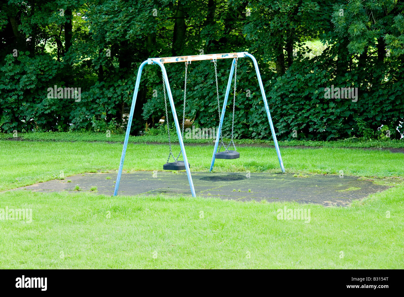 An old rusty swing in a park Stock Photo - Alamy