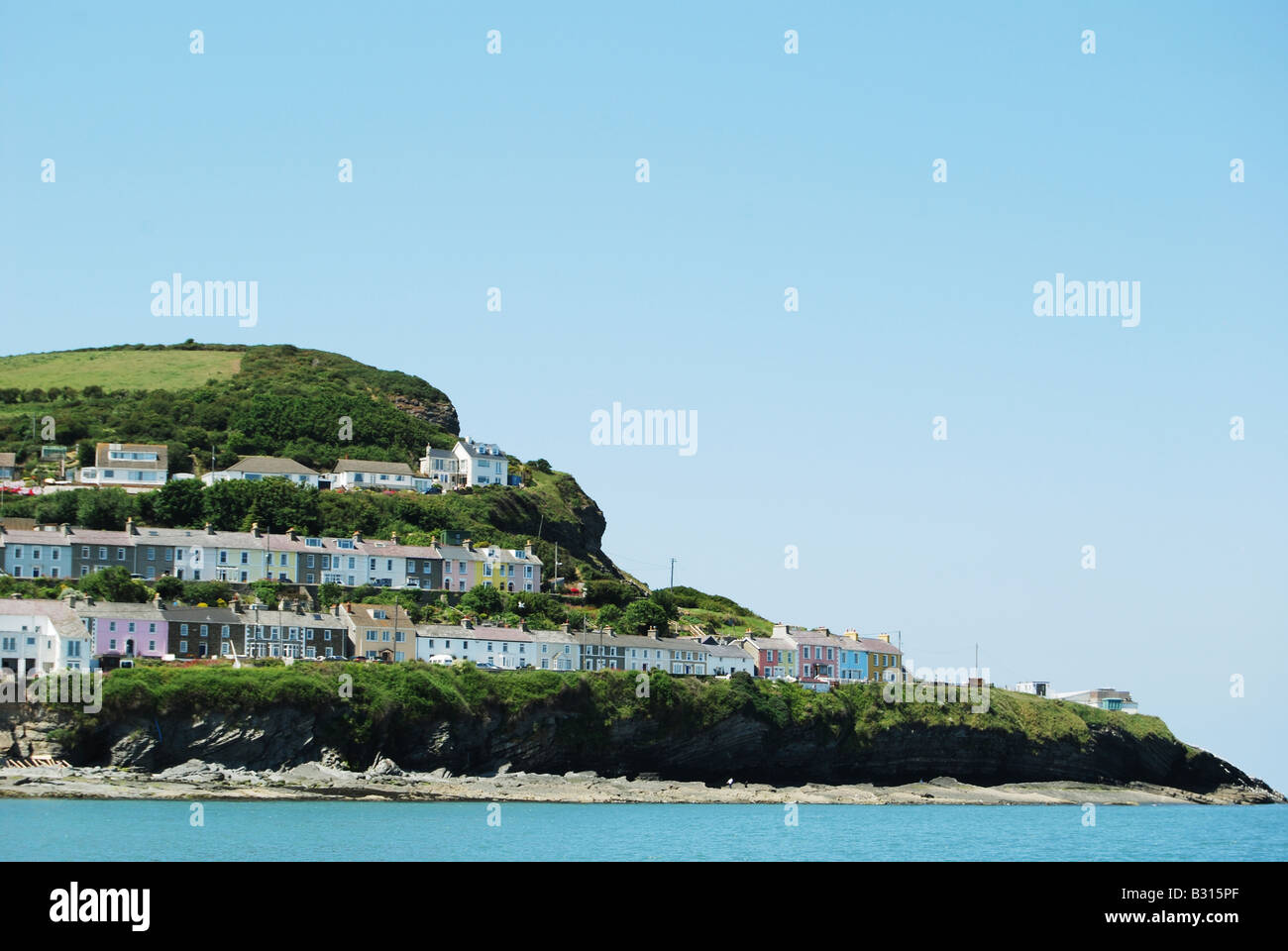Rows of pastel coloured houses at New Quay what Dylan Thomas called the ...