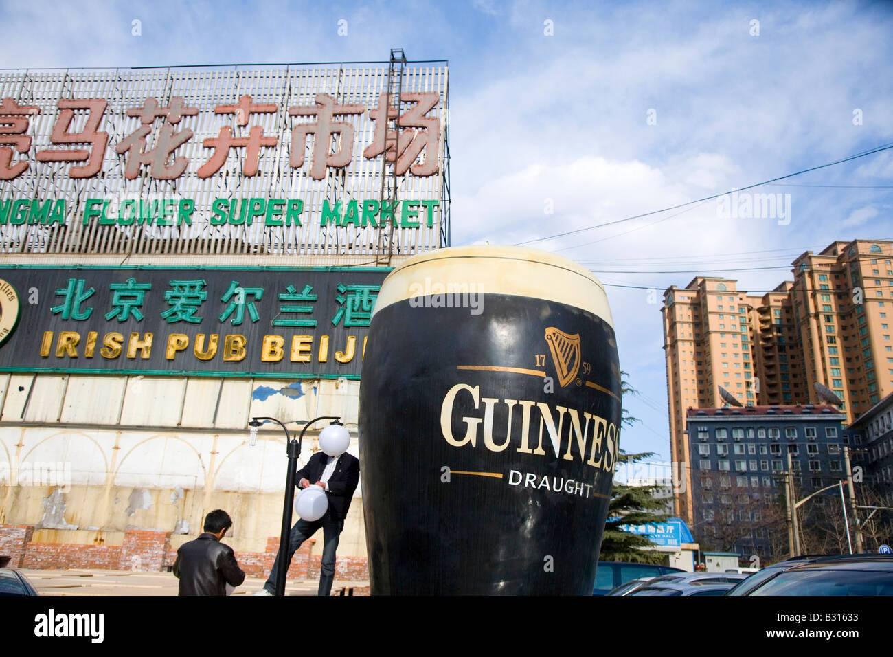 Street scene in Beijing showing advertising promotion of Guiness Stock ...