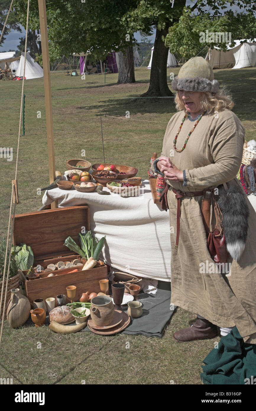 Woman at re-enactment giving a talk on Anglo-Saxon food Stock Photo - Alamy