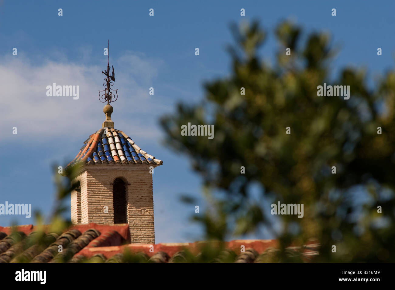 Small Spanish church steeple and weather cock in a small town in the ...