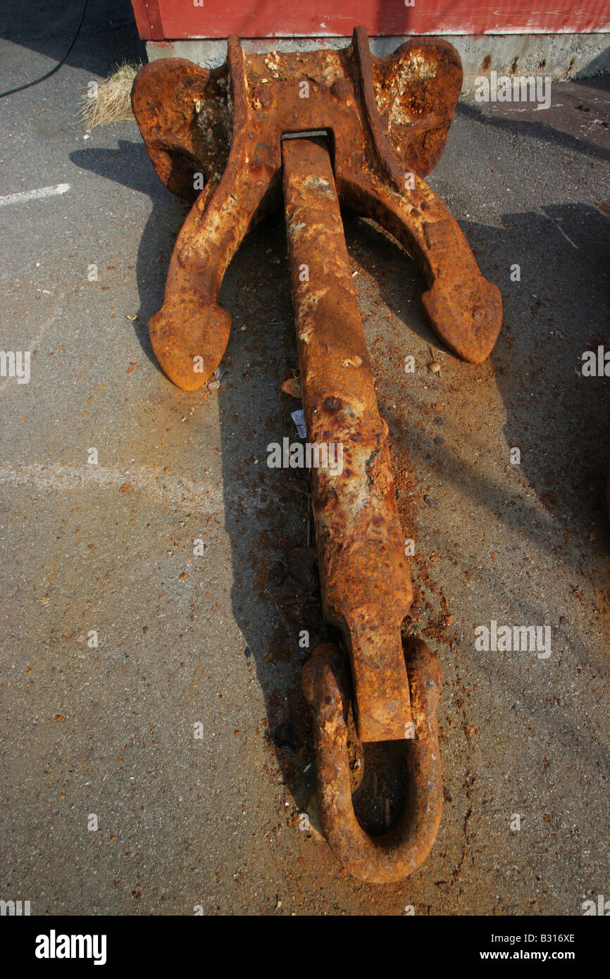 OId rusted anchor dumped on the docks in a small port in Norway Stock ...