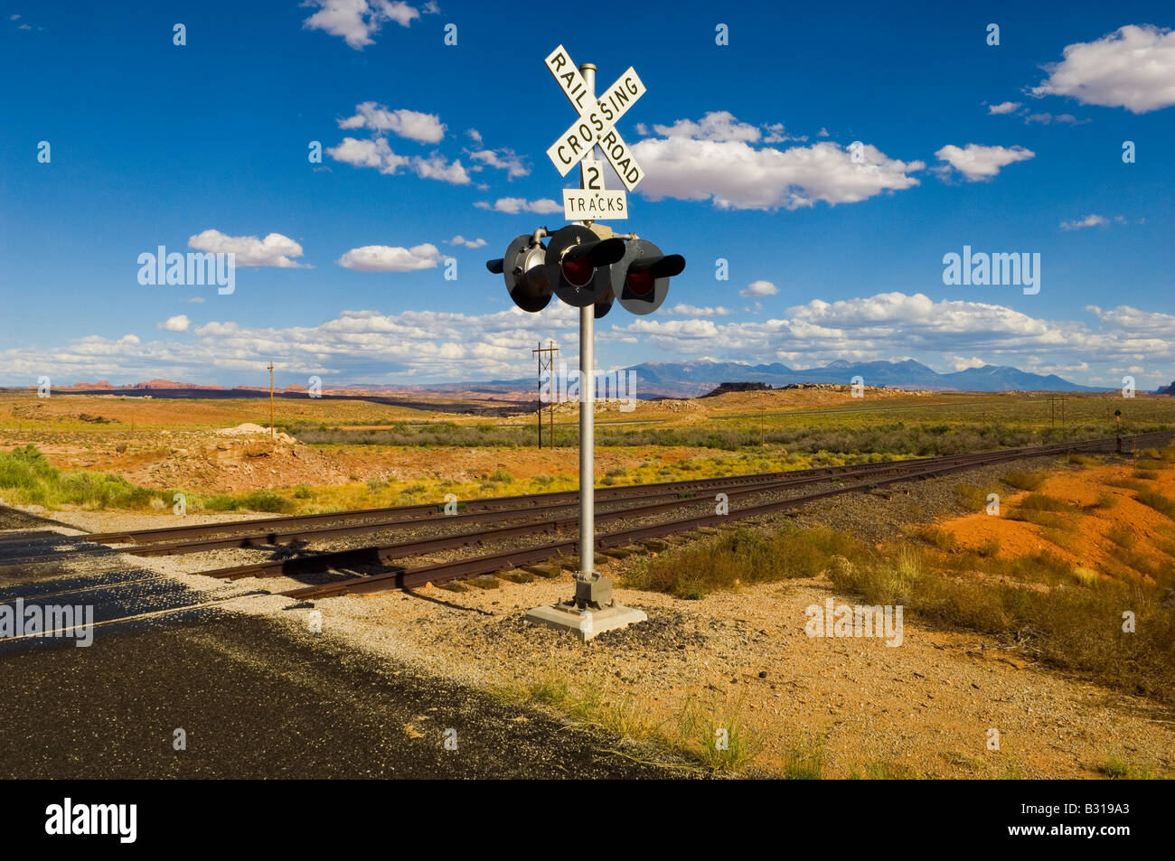 Landscape format colour image of a railway line and level road crossing ...