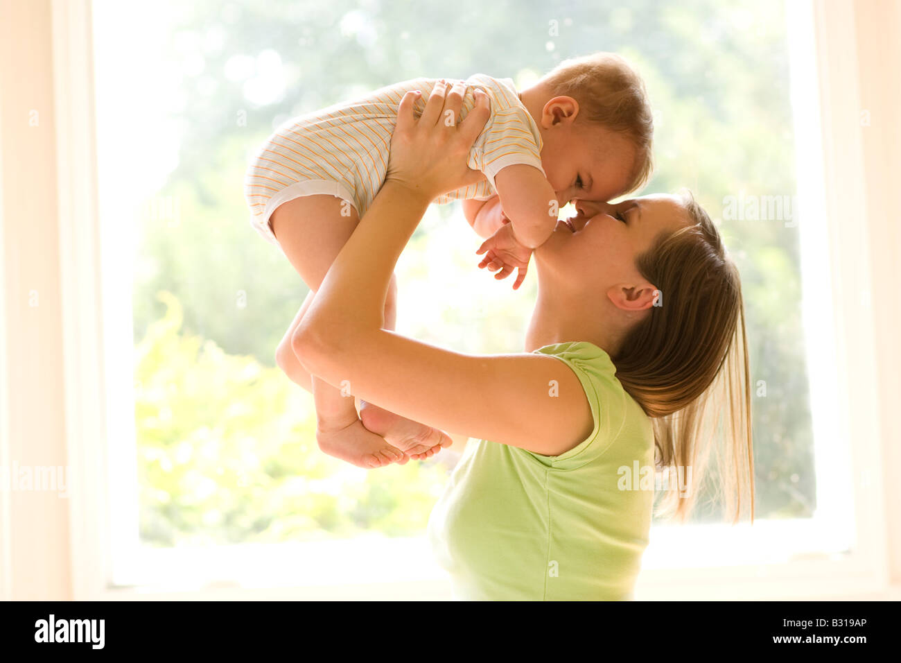 mother lifting baby in the air Stock Photo - Alamy