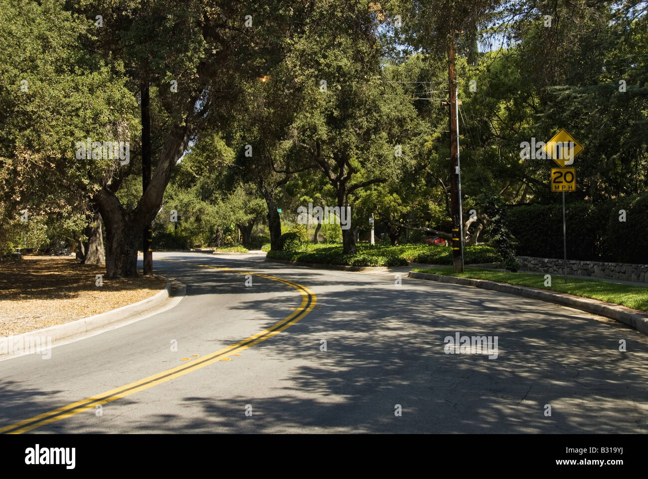 Curved road in neighborhood Stock Photo - Alamy