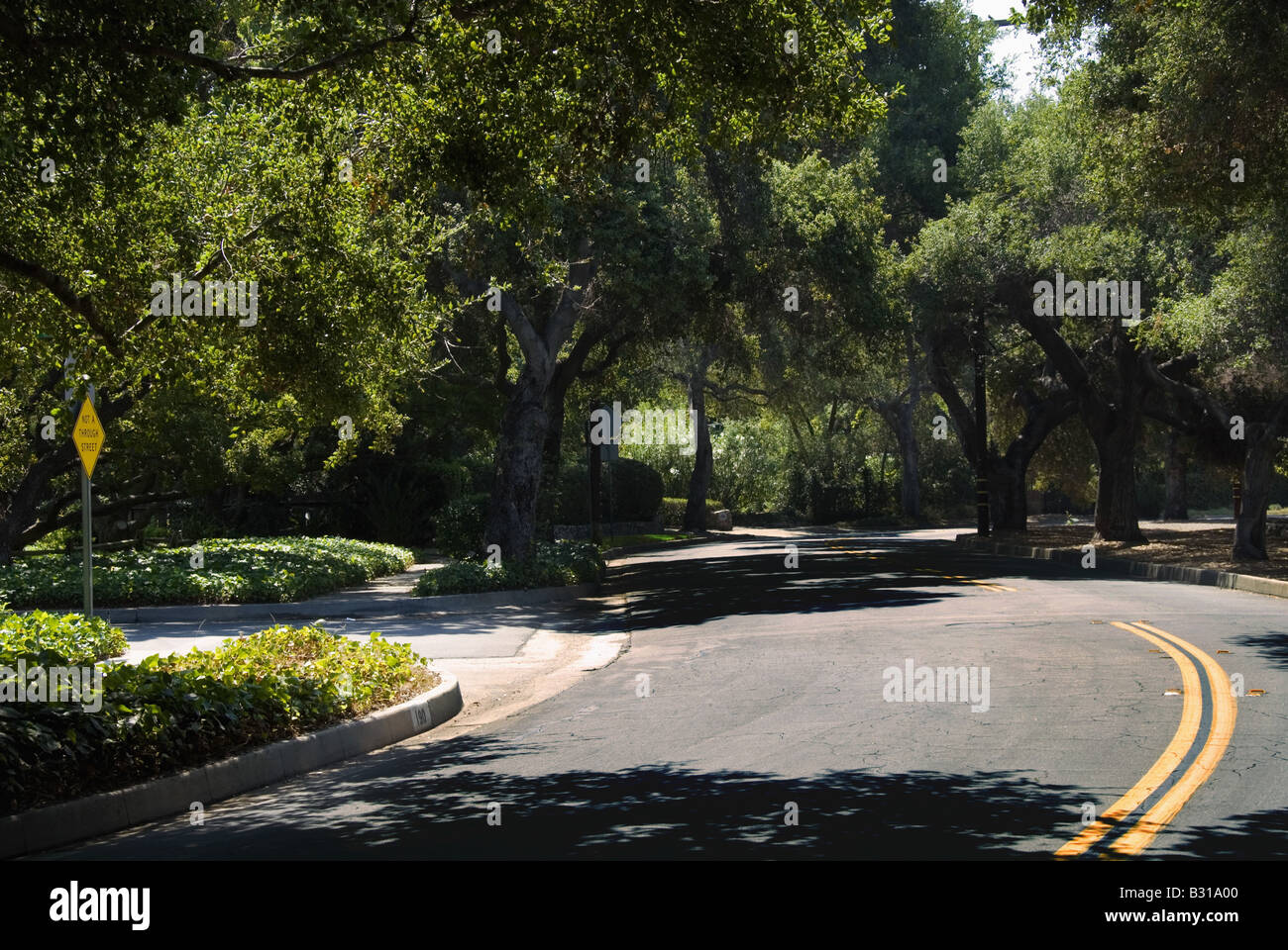 Curved road in neighborhood Stock Photo - Alamy