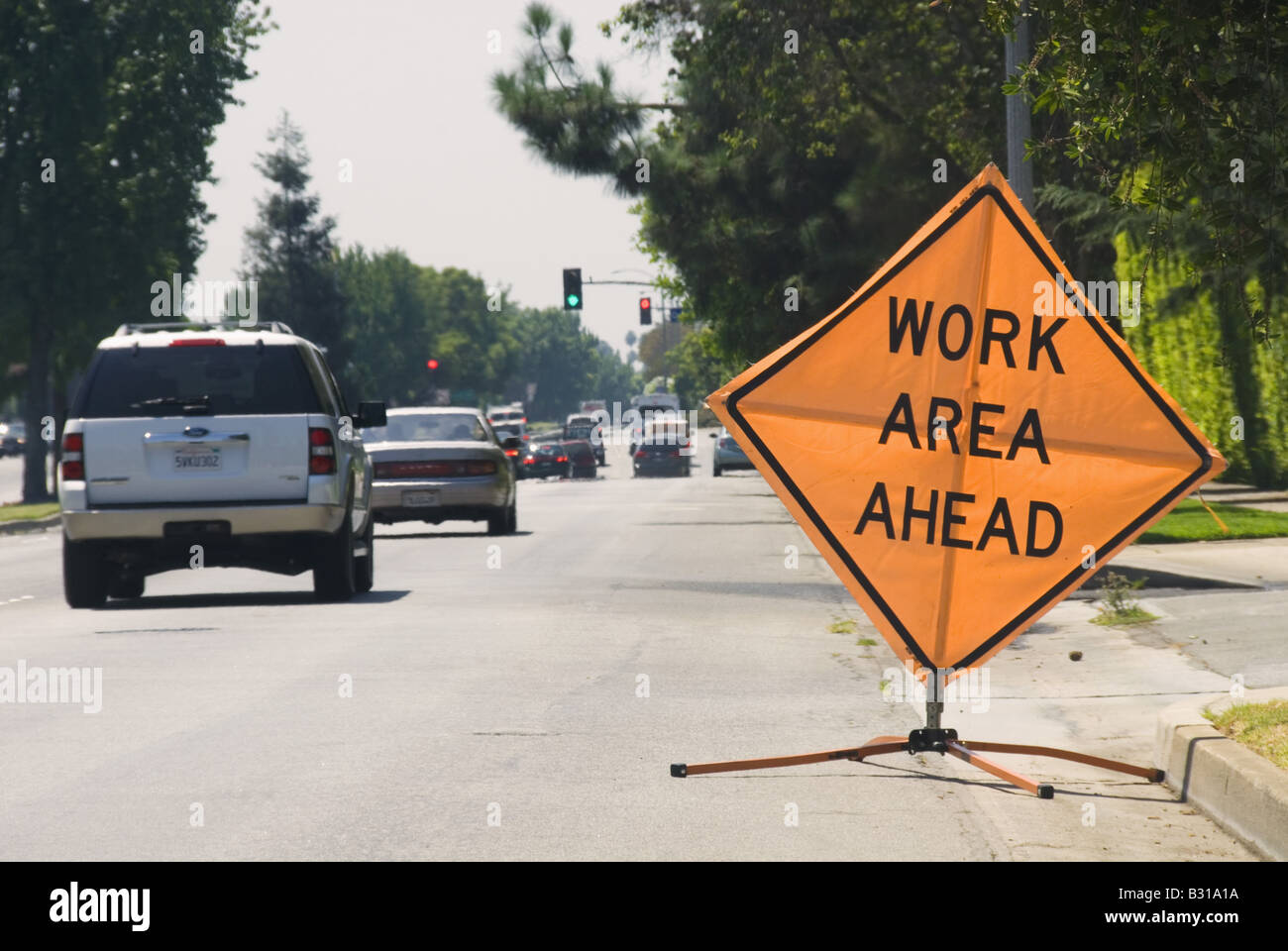 "Work Area Ahead" sign on road with traffic Stock Photo - Alamy