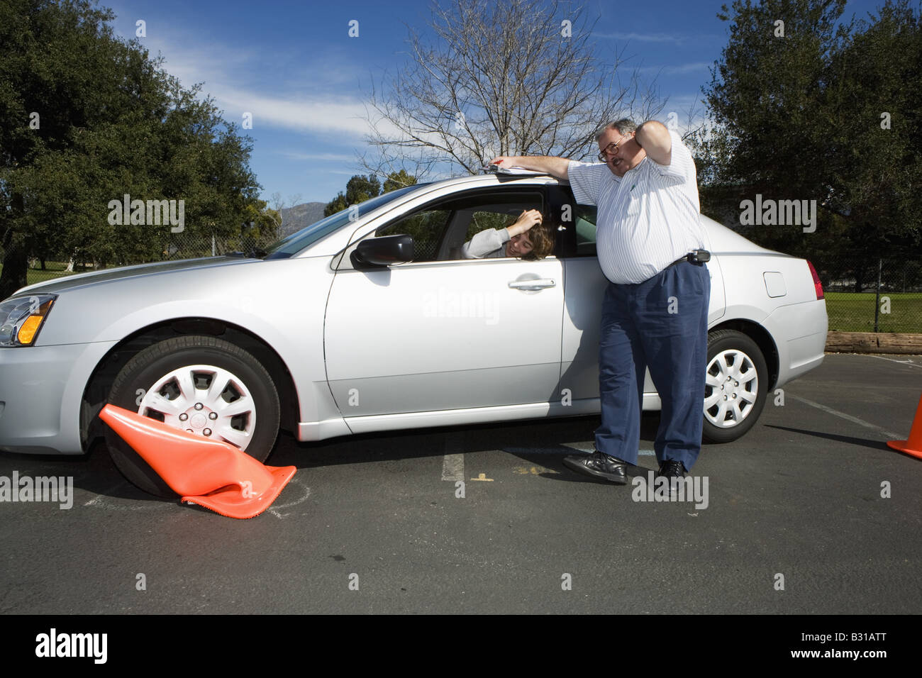 Driving instructor and teen frustrated by driving error Stock Photo - Alamy