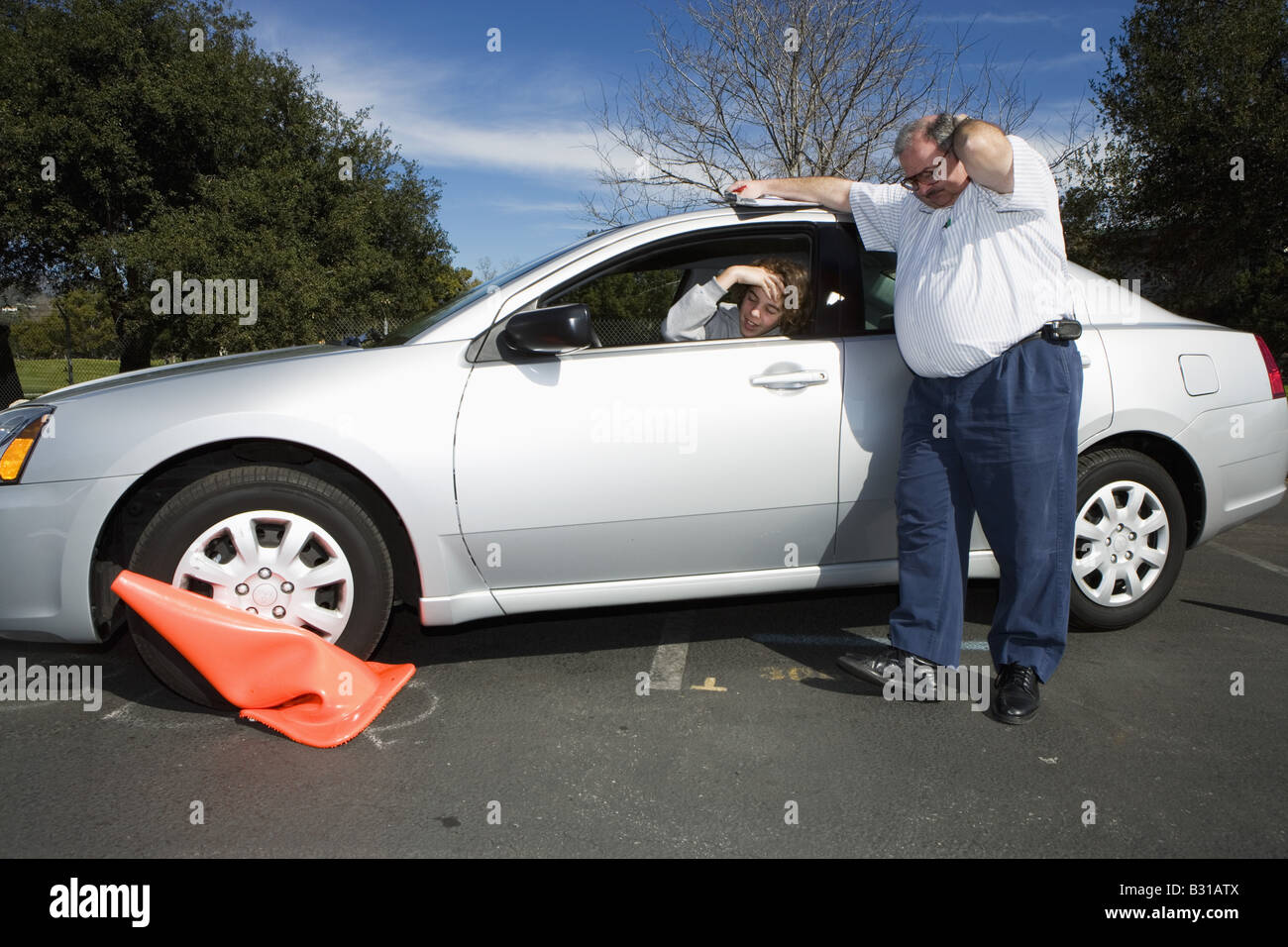 Driving instructor and teen frustrated by driving error Stock Photo - Alamy