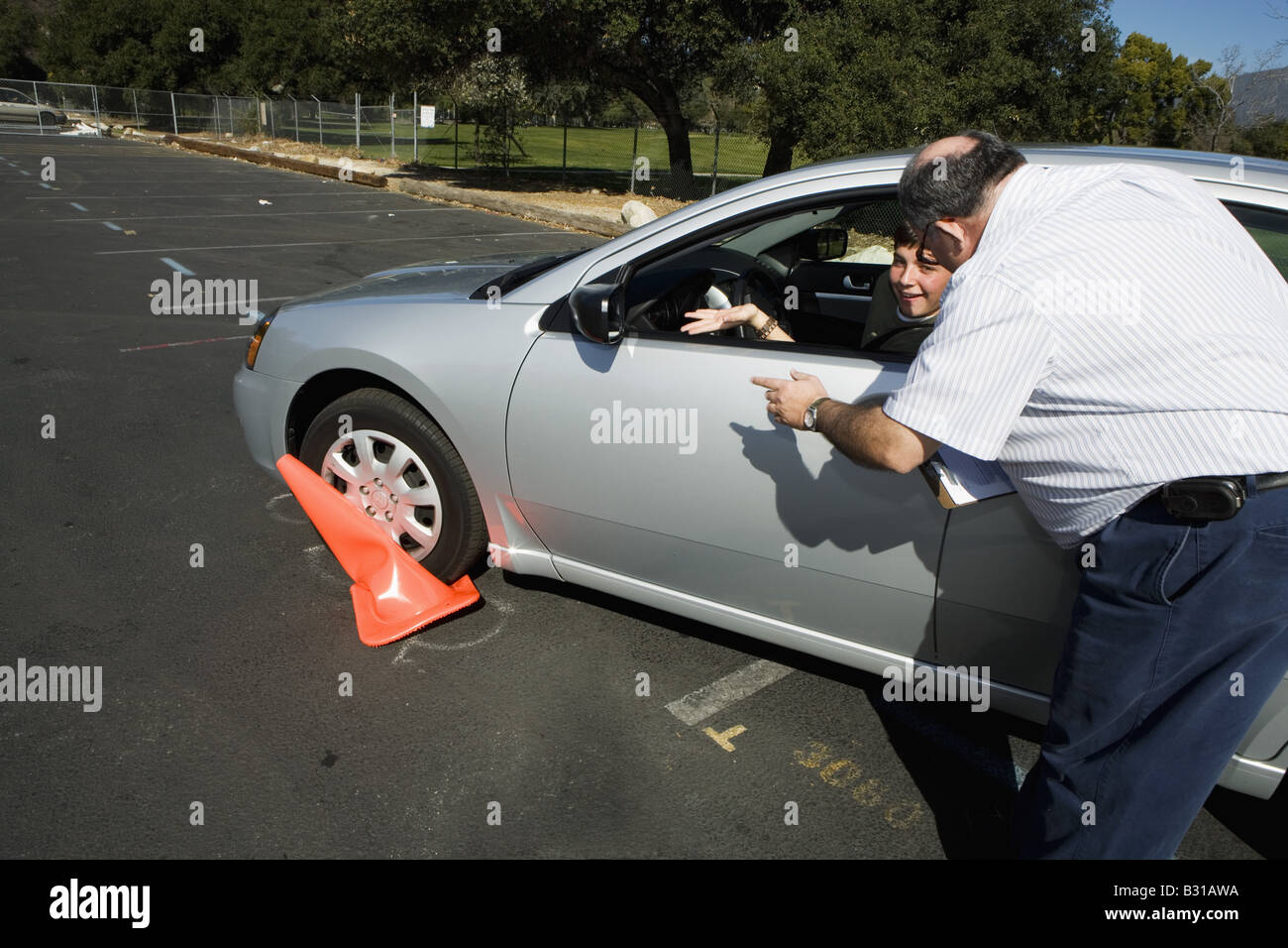 Driving instructor points out crushed cone to teen driver Stock Photo ...