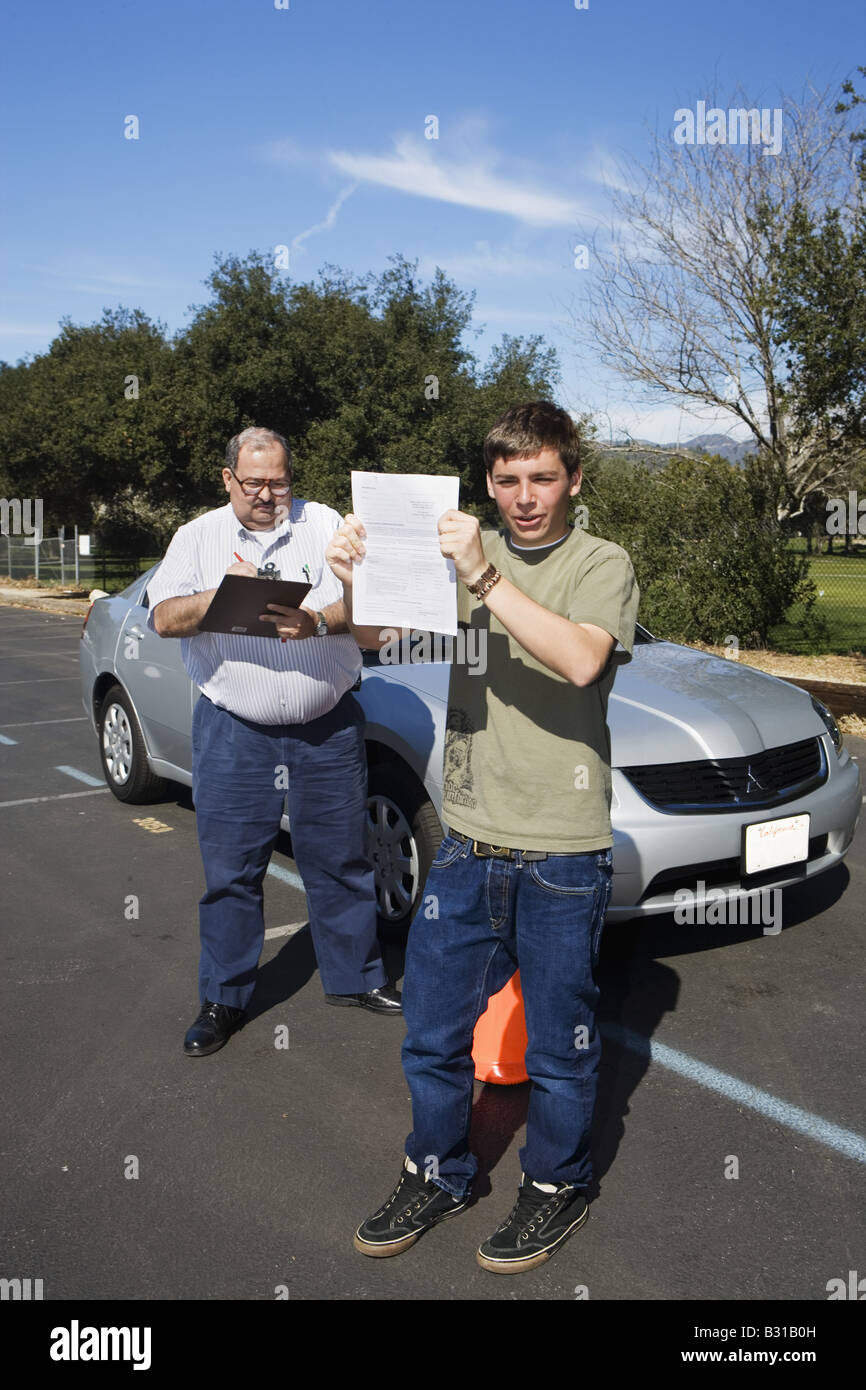 Teen boy passes driving test Stock Photo - Alamy