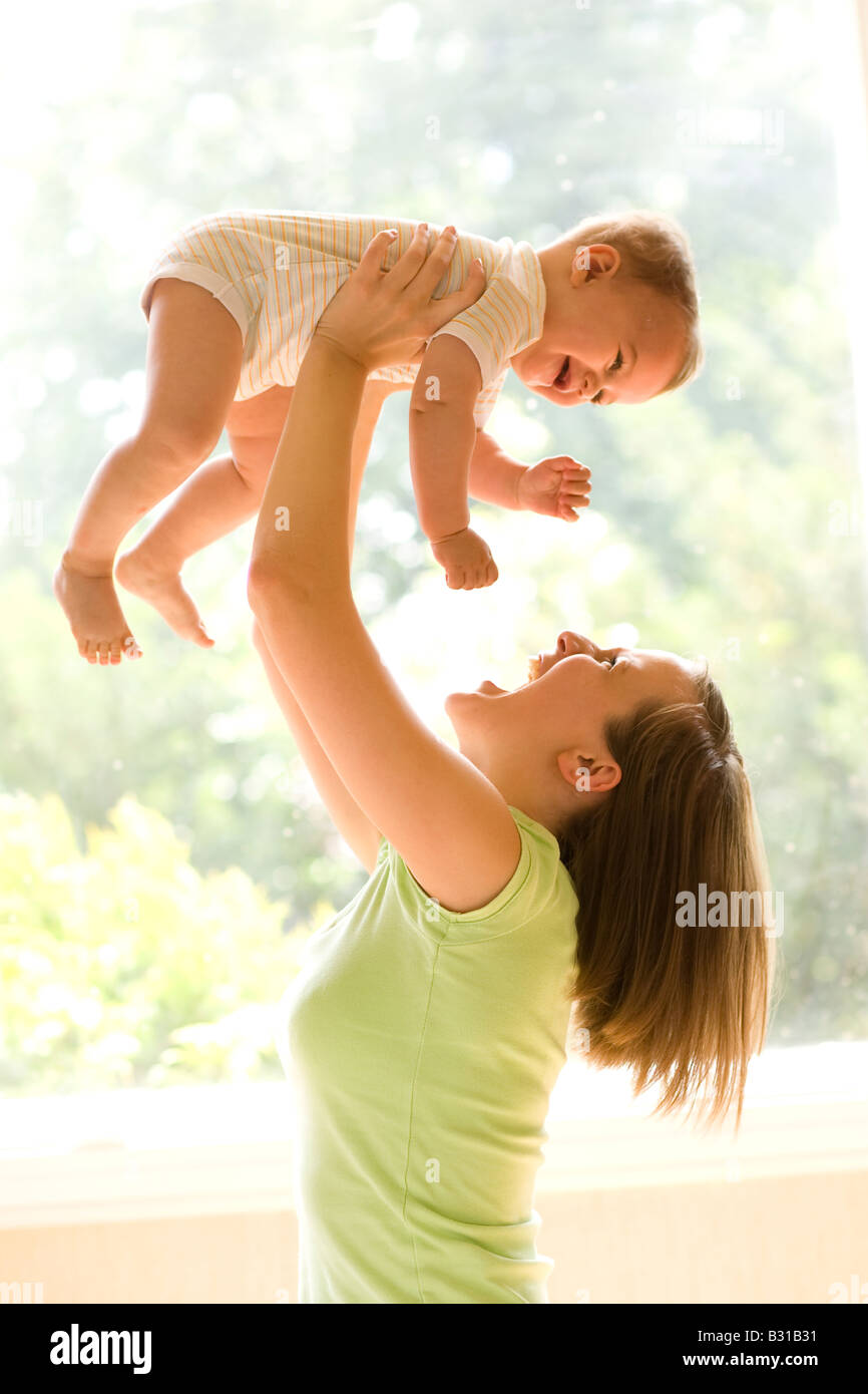 mother lifting baby in the air Stock Photo - Alamy