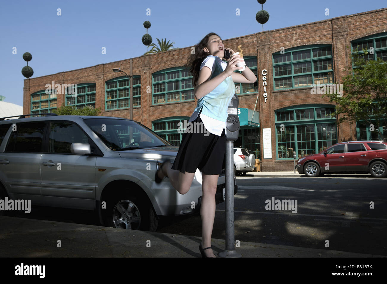 Young woman tripping up with cup of coffee Stock Photo - Alamy