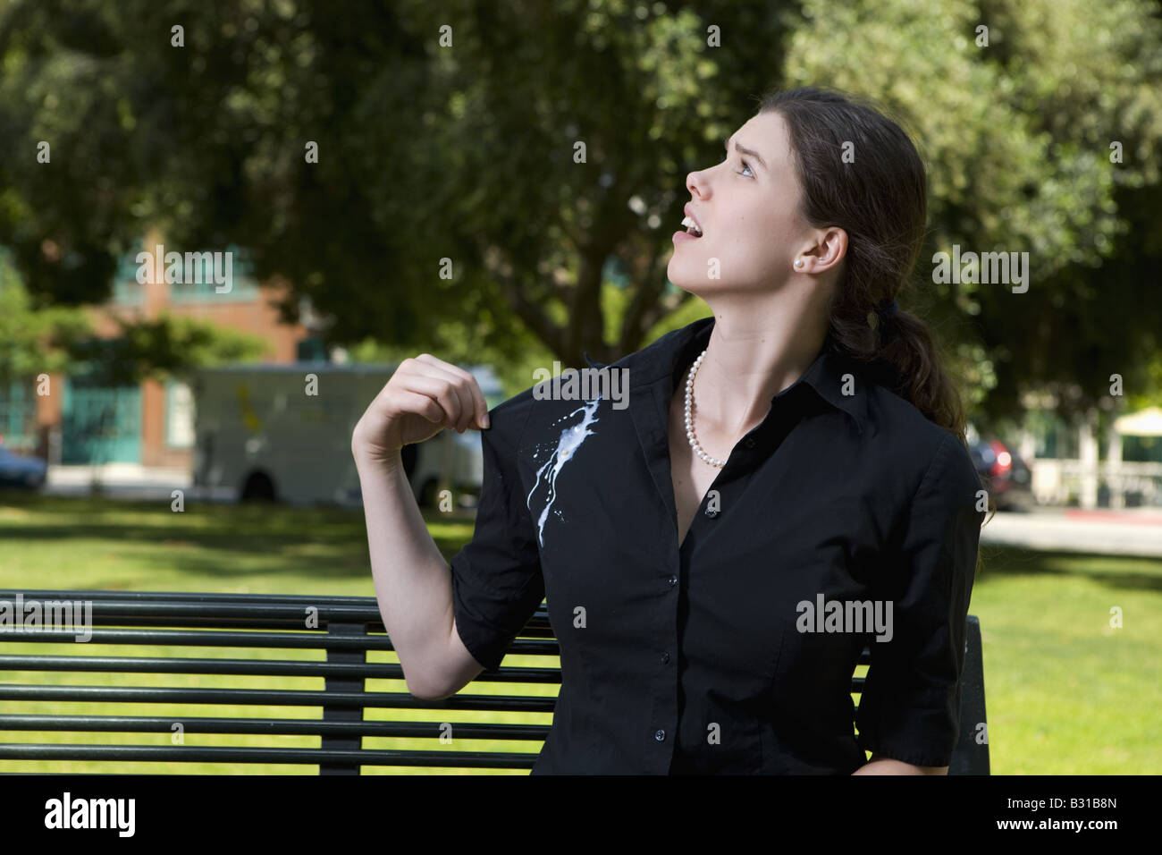 Young woman with bird droppings on dress Stock Photo - Alamy