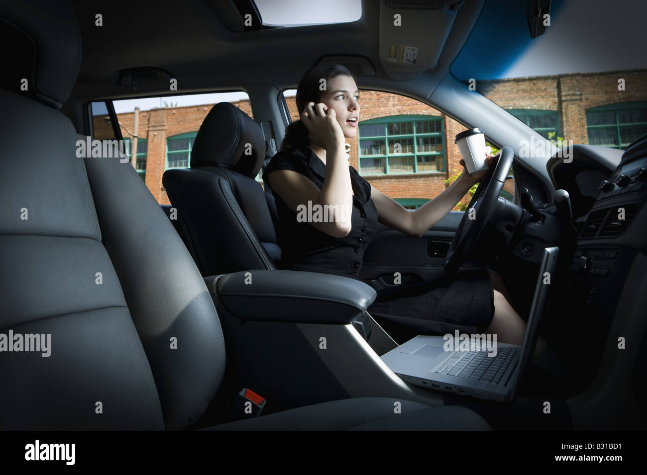 Young woman talking on cellphone while driving Stock Photo - Alamy