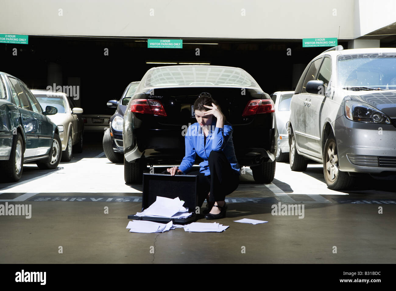 Woman kneeling by papers hi-res stock photography and images - Alamy
