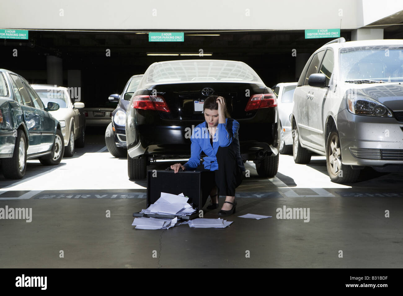 Woman kneeling by papers hi-res stock photography and images - Alamy
