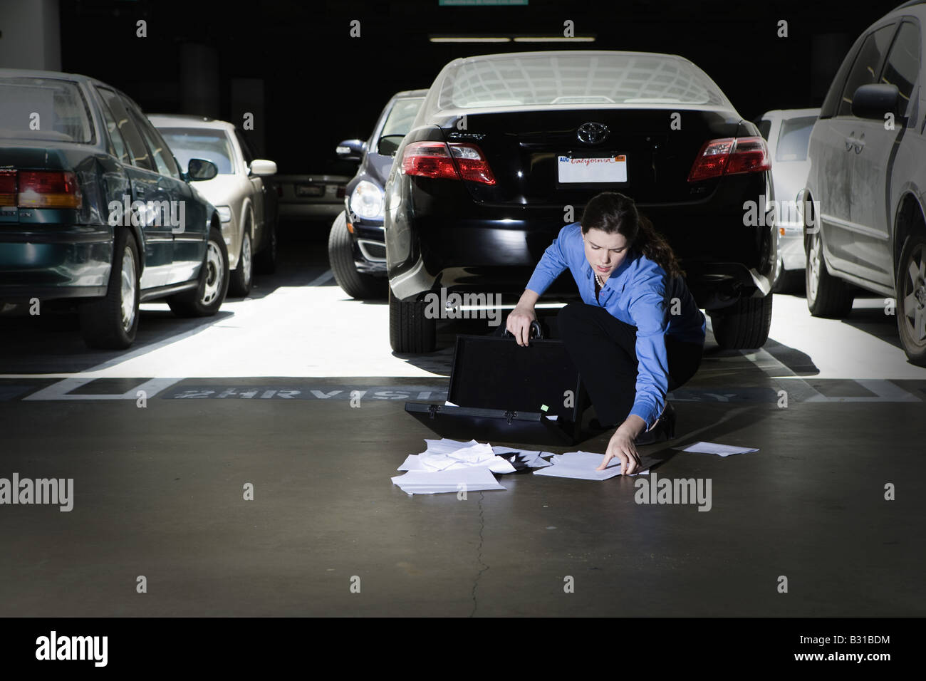 Woman picking up papers hi-res stock photography and images - Alamy