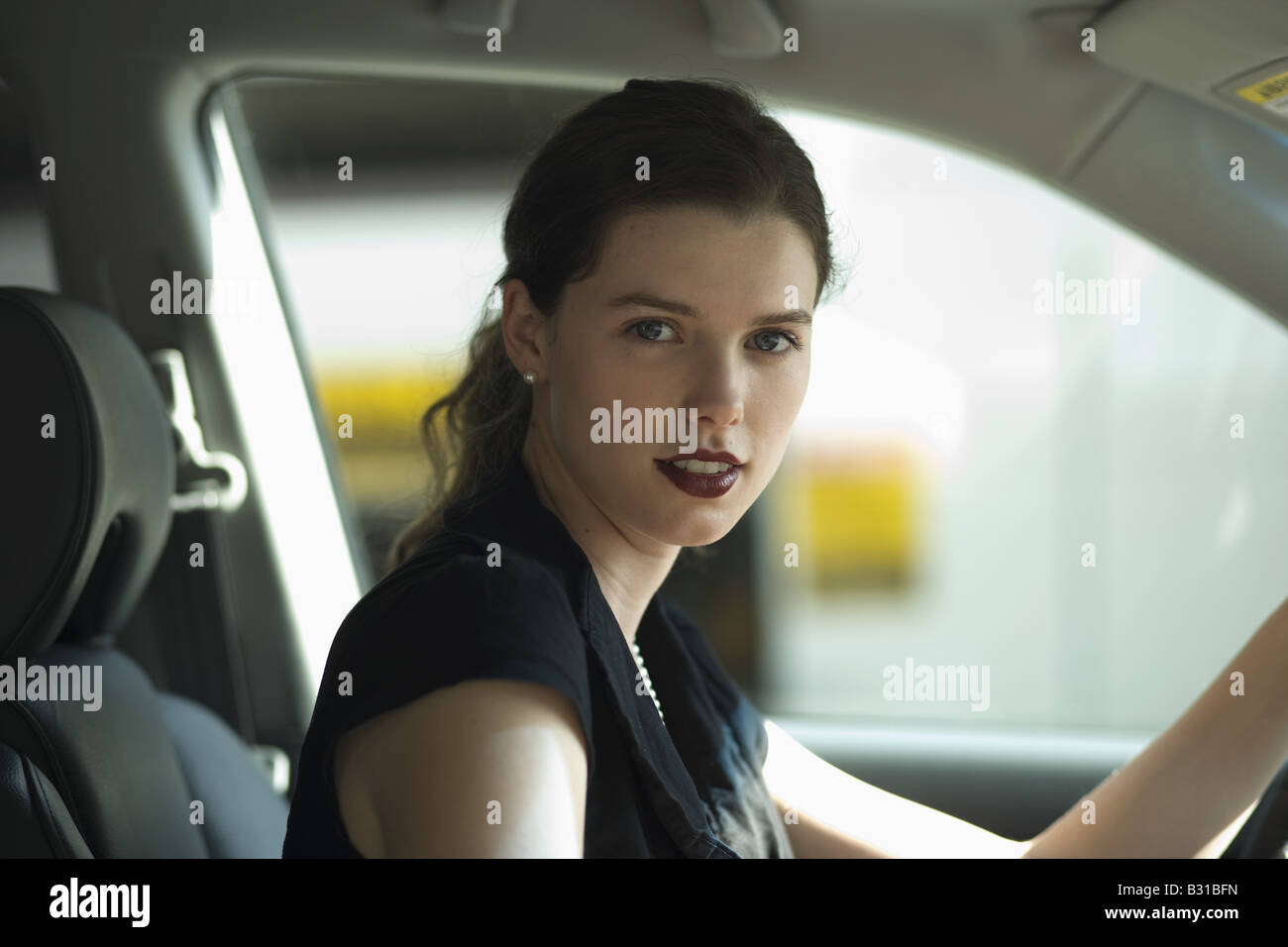 Young woman seated in SUV Stock Photo - Alamy