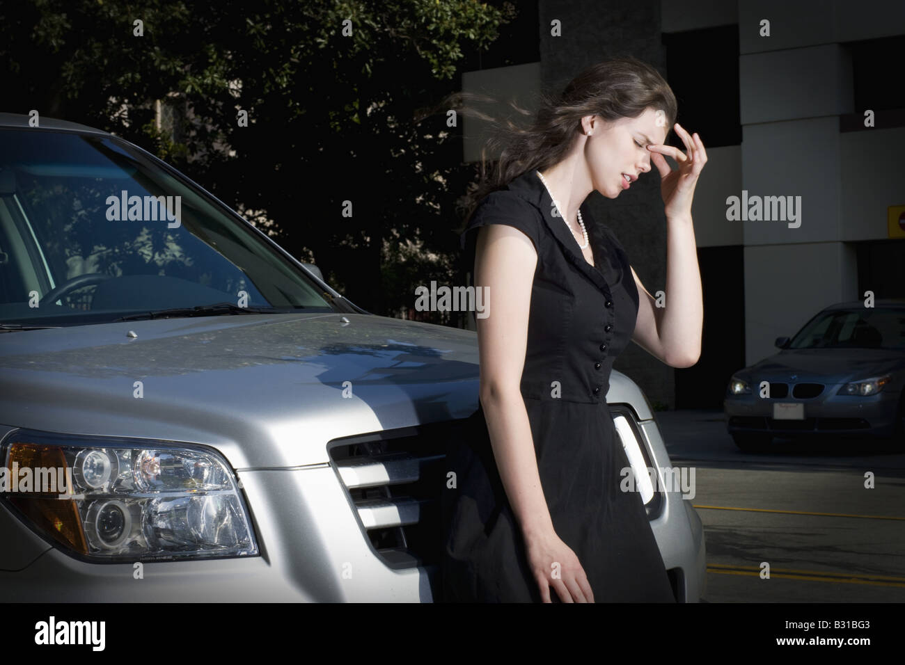 Young woman with headache by front of Honda Pilot Stock Photo - Alamy