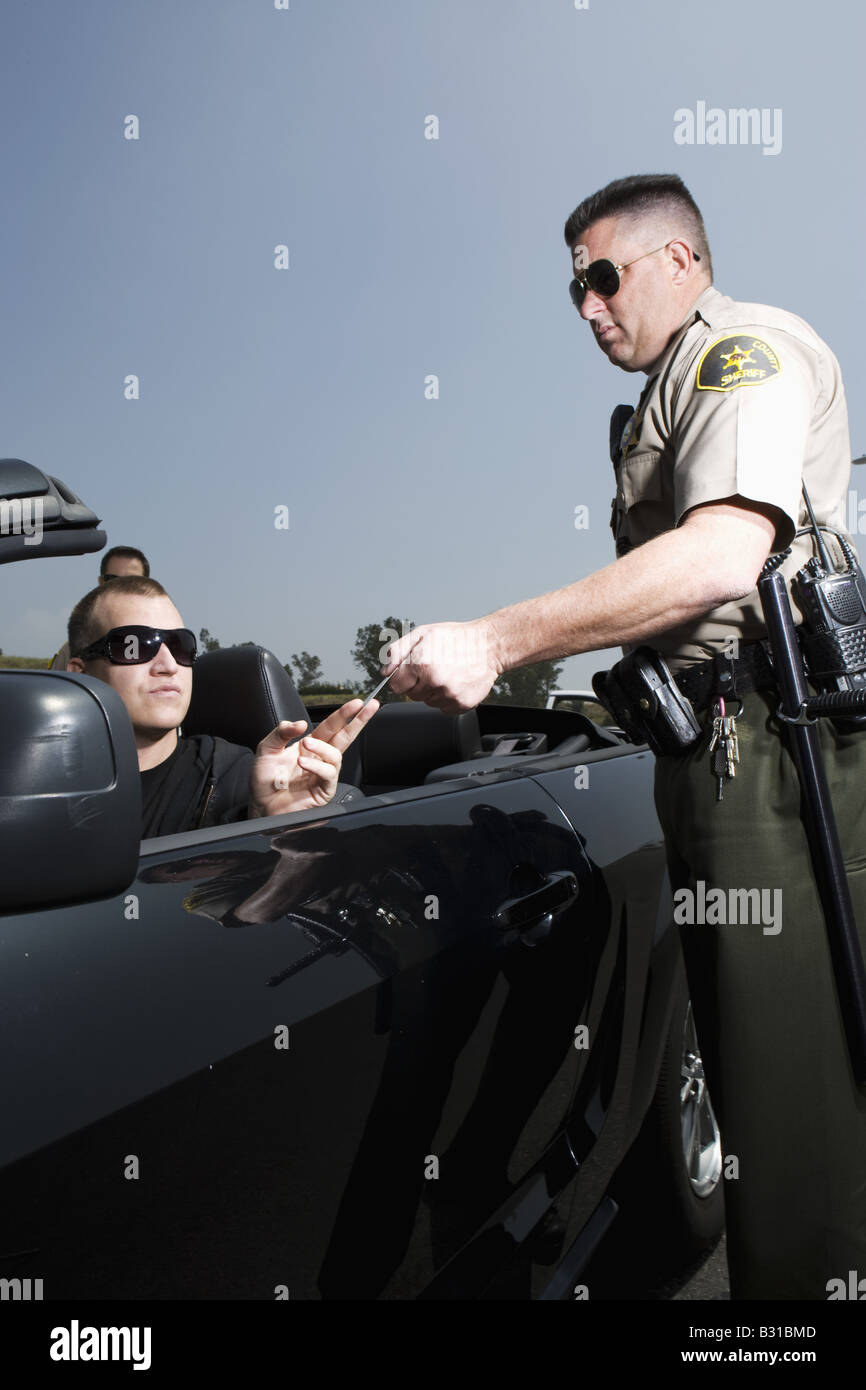 Man in Mustang handing police officer drivers license Stock Photo - Alamy