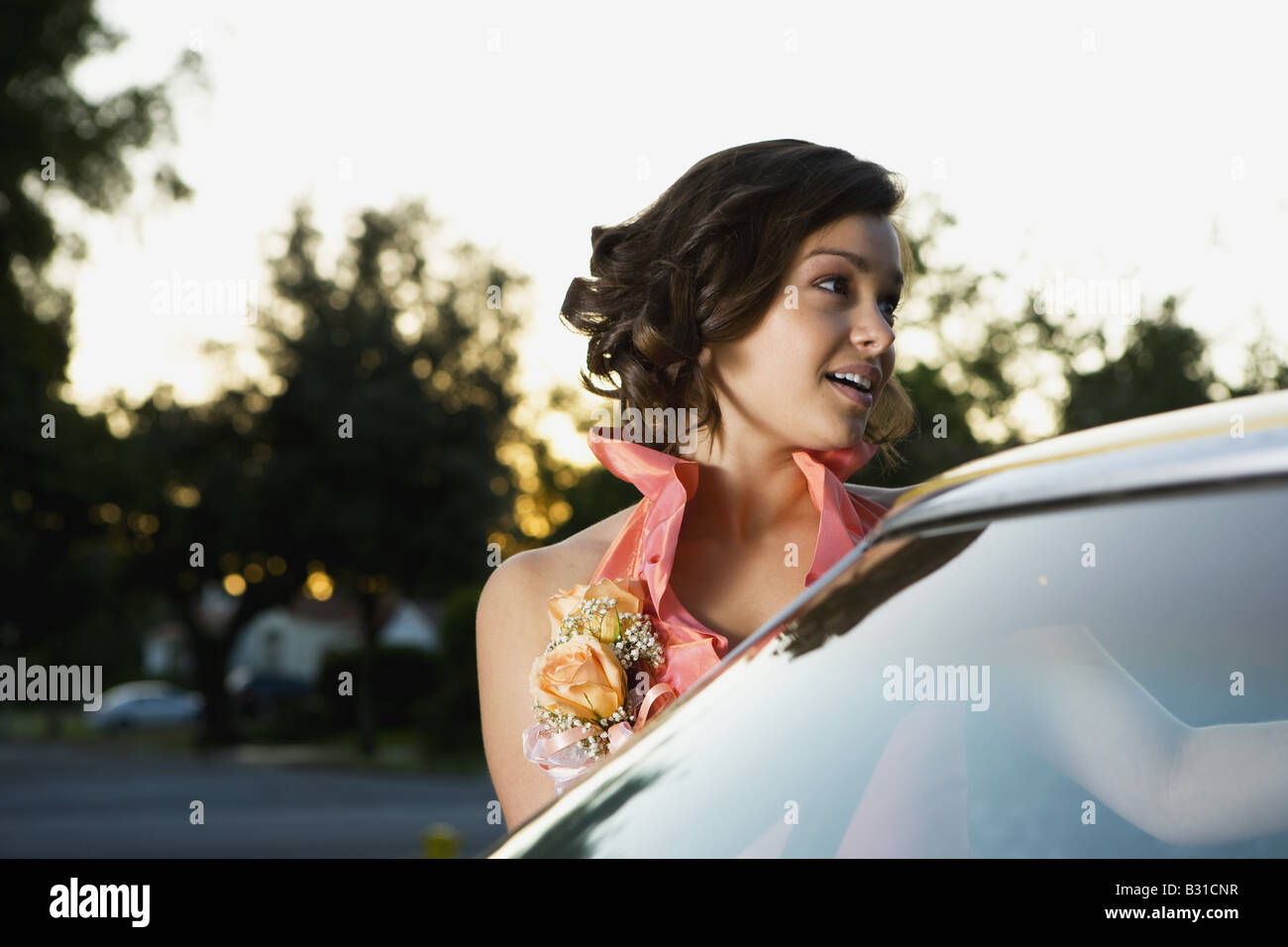 Young woman prom goer by side of car Stock Photo - Alamy