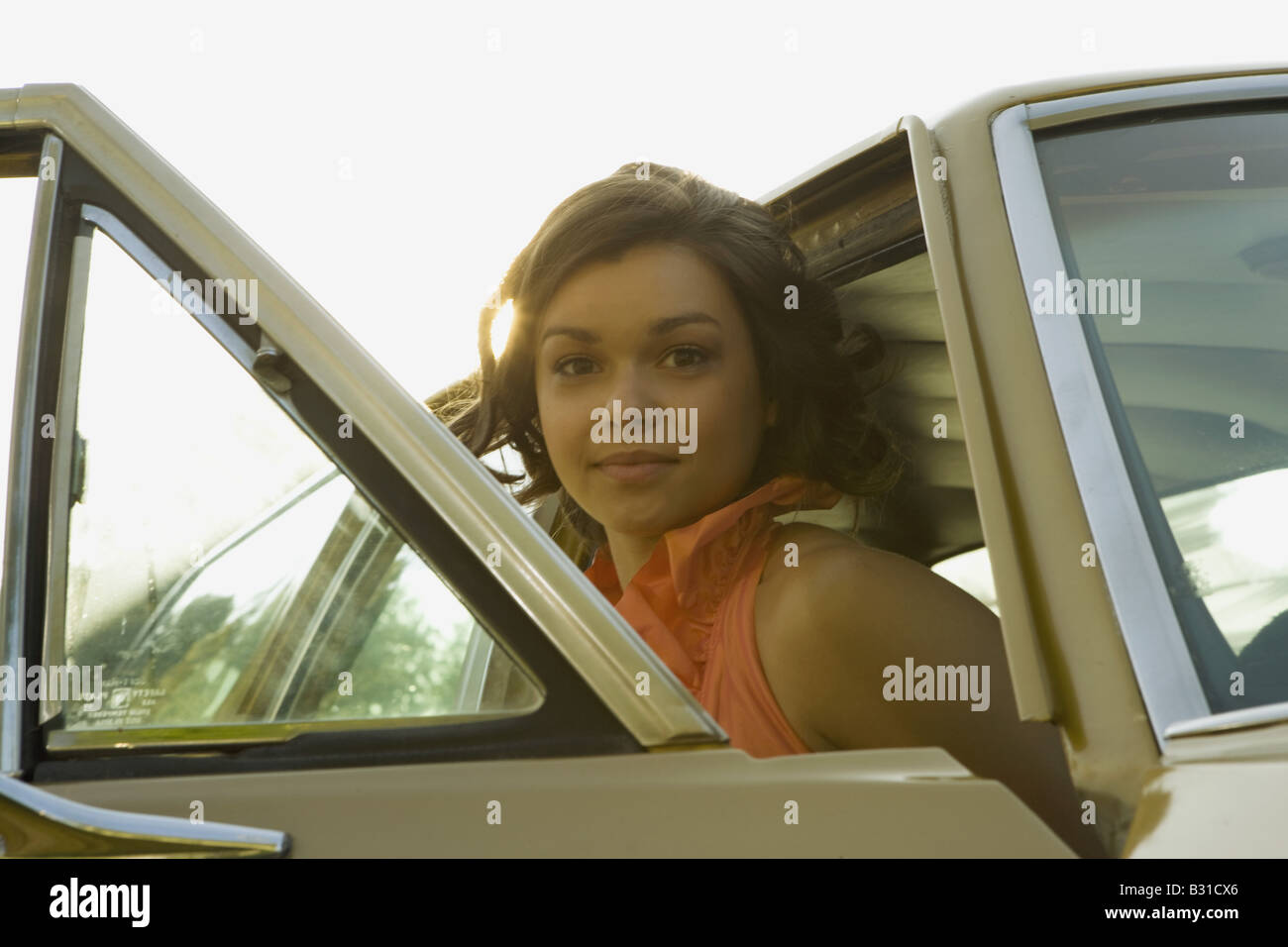 Young woman getting out of car Stock Photo - Alamy