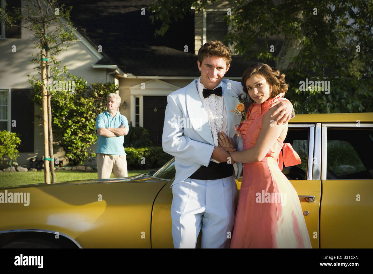Prom goers standing by side of car Stock Photo - Alamy