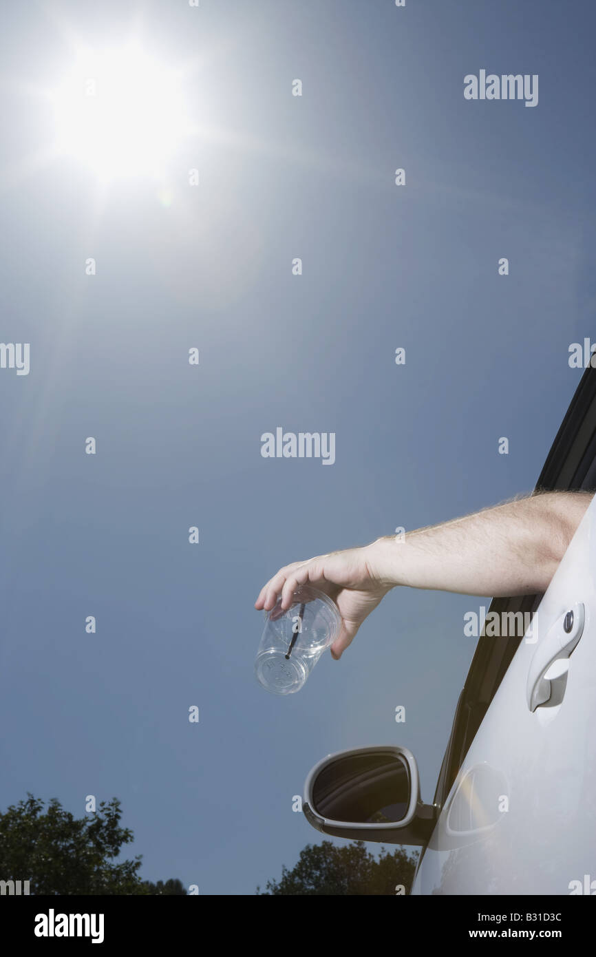 Man throwing plastic cup out of car window Stock Photo - Alamy
