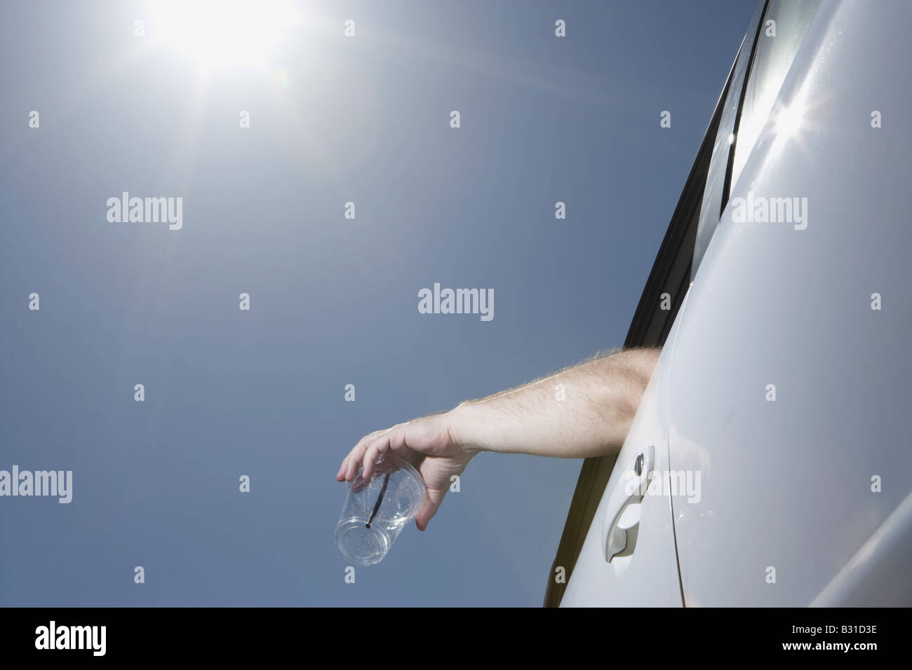 Man throwing plastic cup out of car window Stock Photo - Alamy