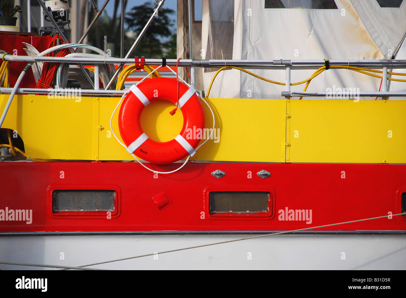Colorful boat with throwable life saving device Stock Photo - Alamy