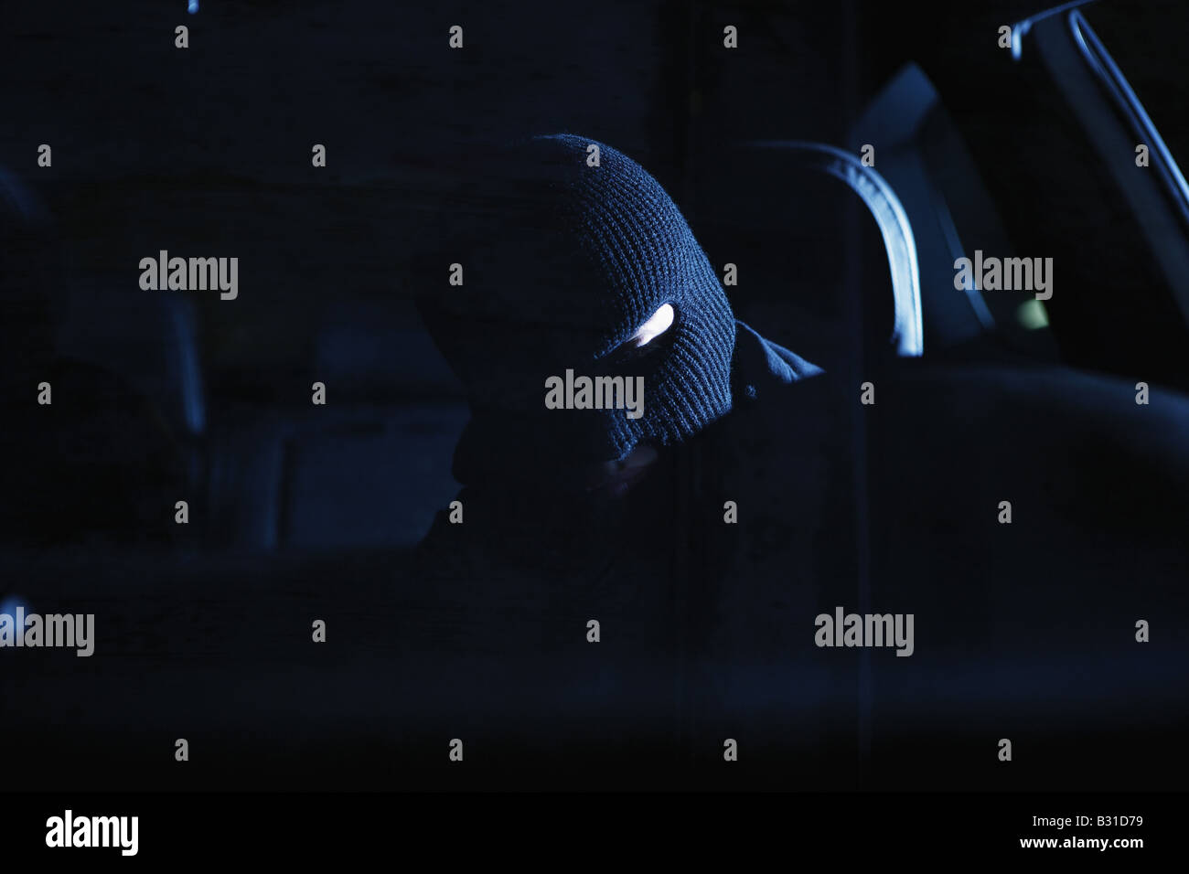 Front profile of masked thief stealing car Stock Photo - Alamy