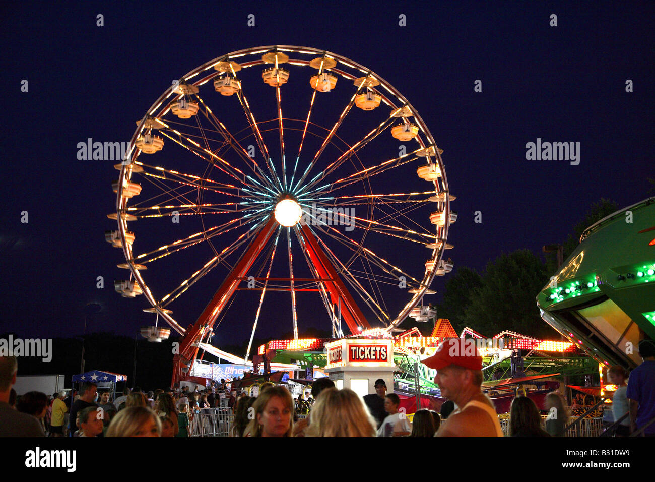 The Big Wheel Or Funfair Ferris Wheel All Lit Up At Night From Across