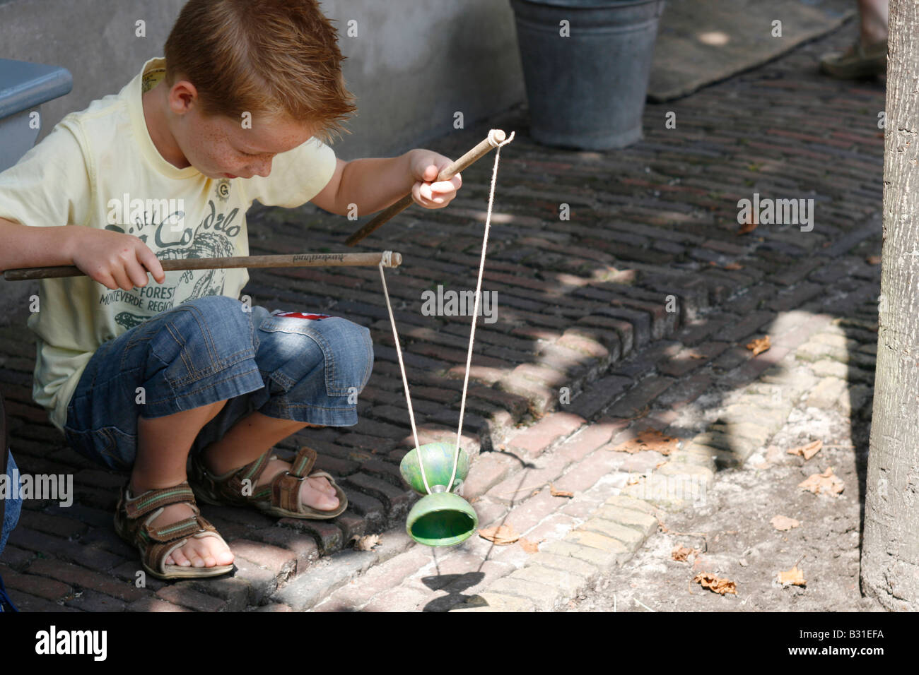 Boy playing diabolo intense balance balancing child hi-res stock ...