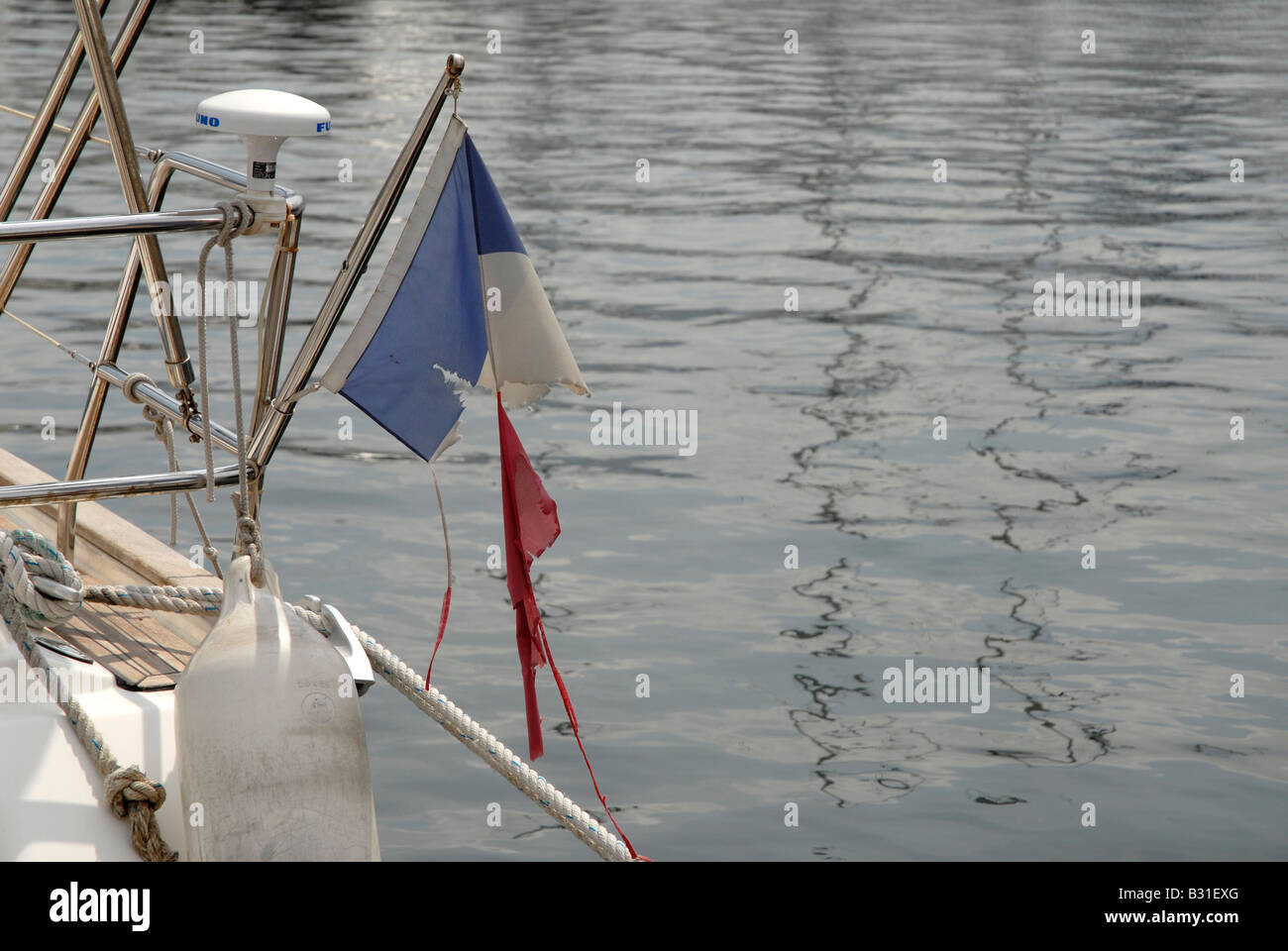 torn French tricolour flag on the stern of a private boat Stock Photo ...