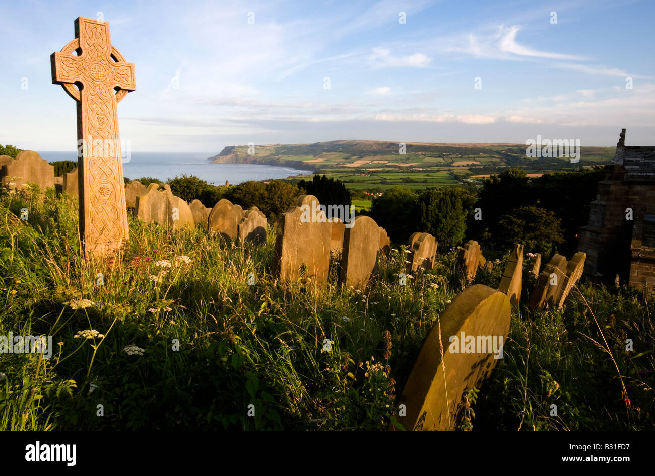 Cross in graveyard overlooking graveyard Stock Photo - Alamy