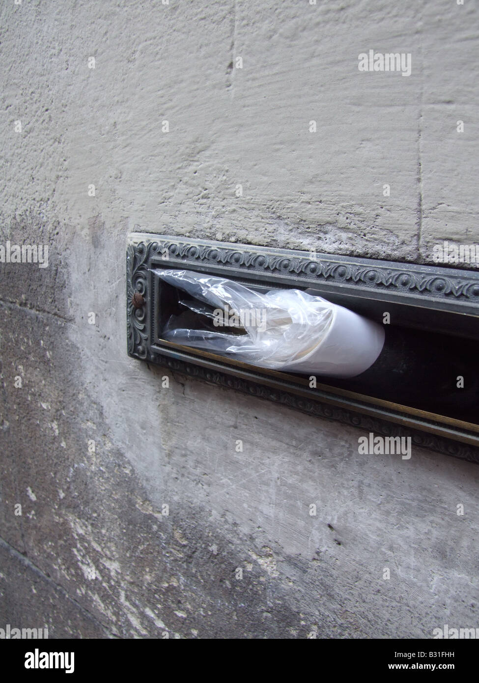 one letter left in house door letterbox slot Stock Photo - Alamy