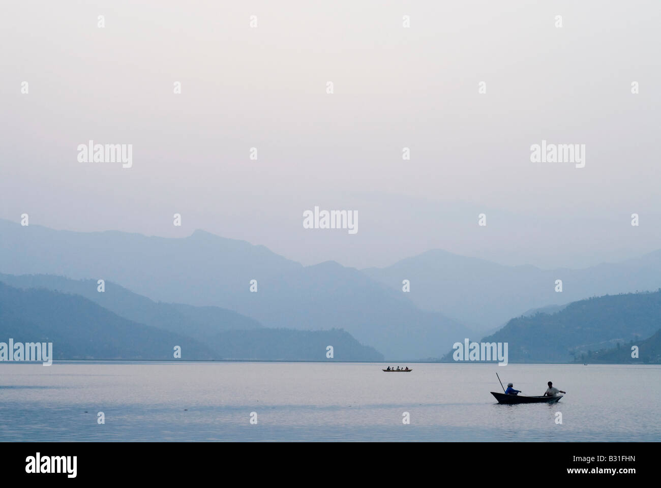Phewa lake at sunset with fishing boats, Pokhara, Nepal Stock Photo - Alamy