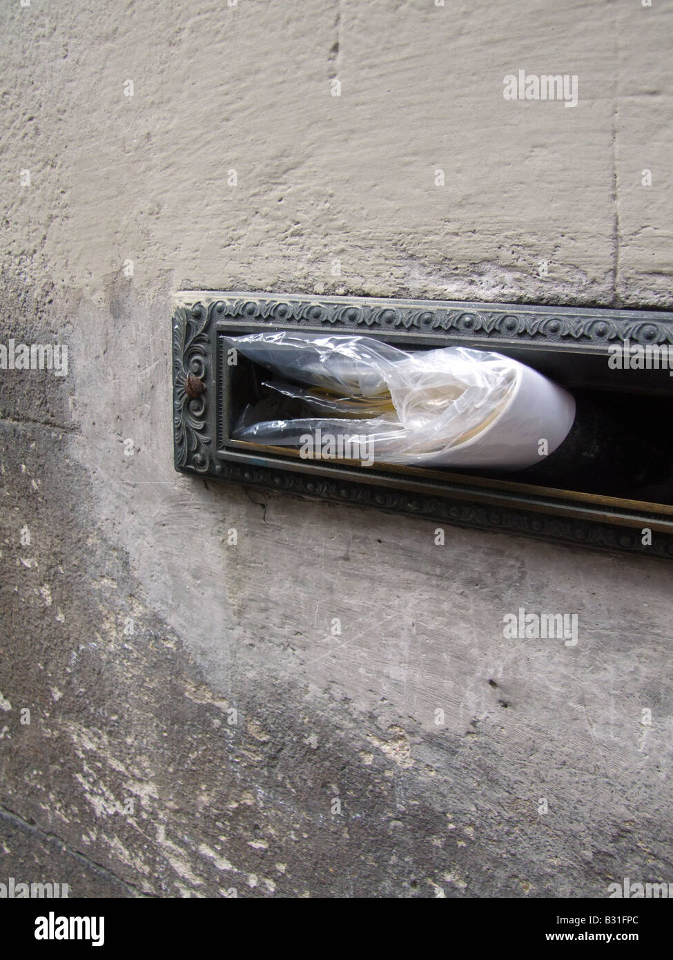 one letter left in house door letterbox slot Stock Photo - Alamy