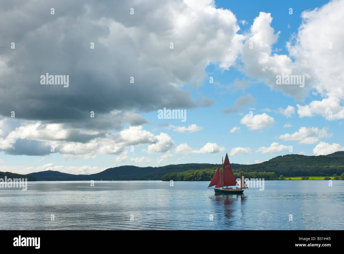 Boat with red sails on Lake Windermere, Lake District National Park ...