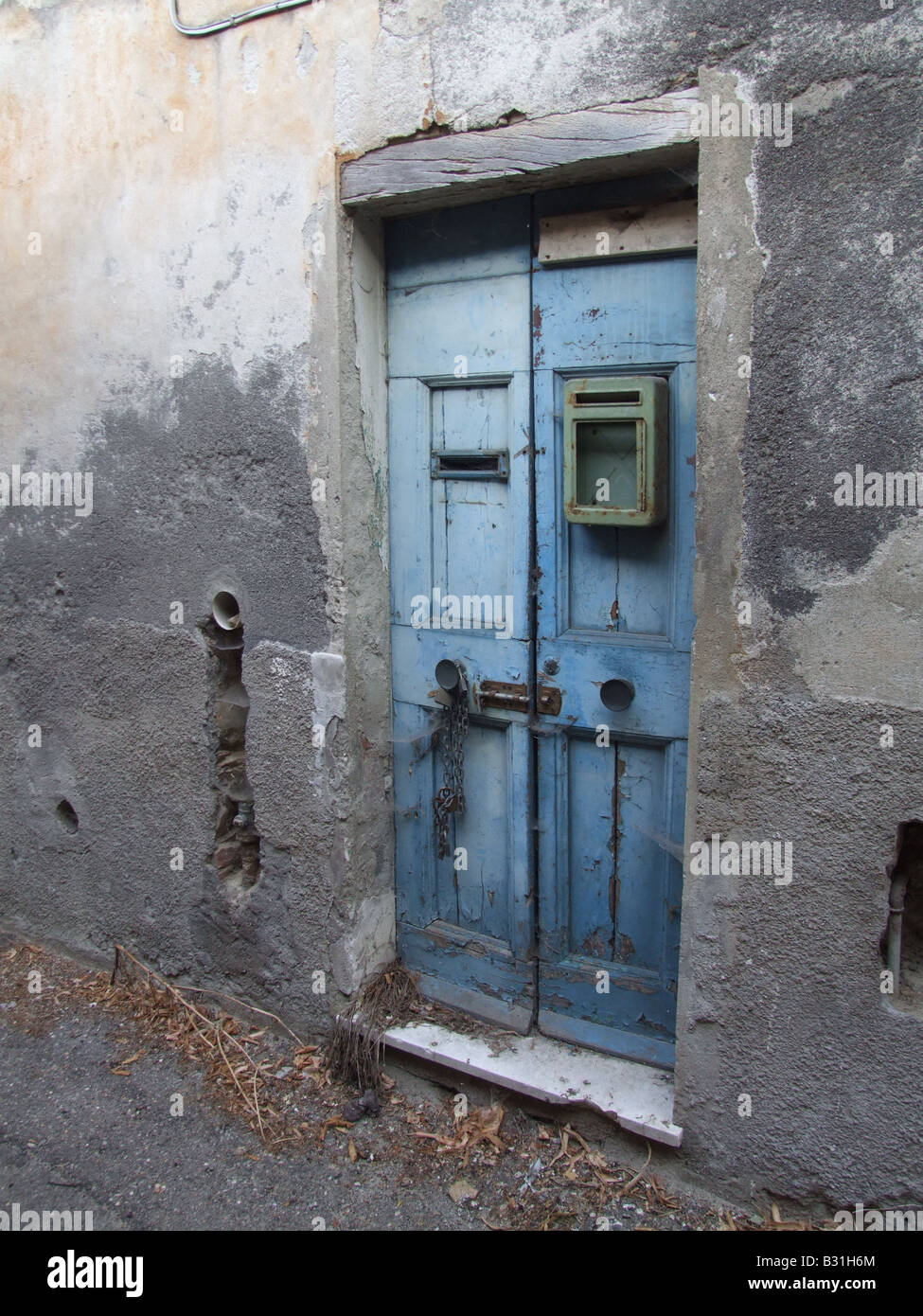 old damaged blue wooden door on home Stock Photo - Alamy